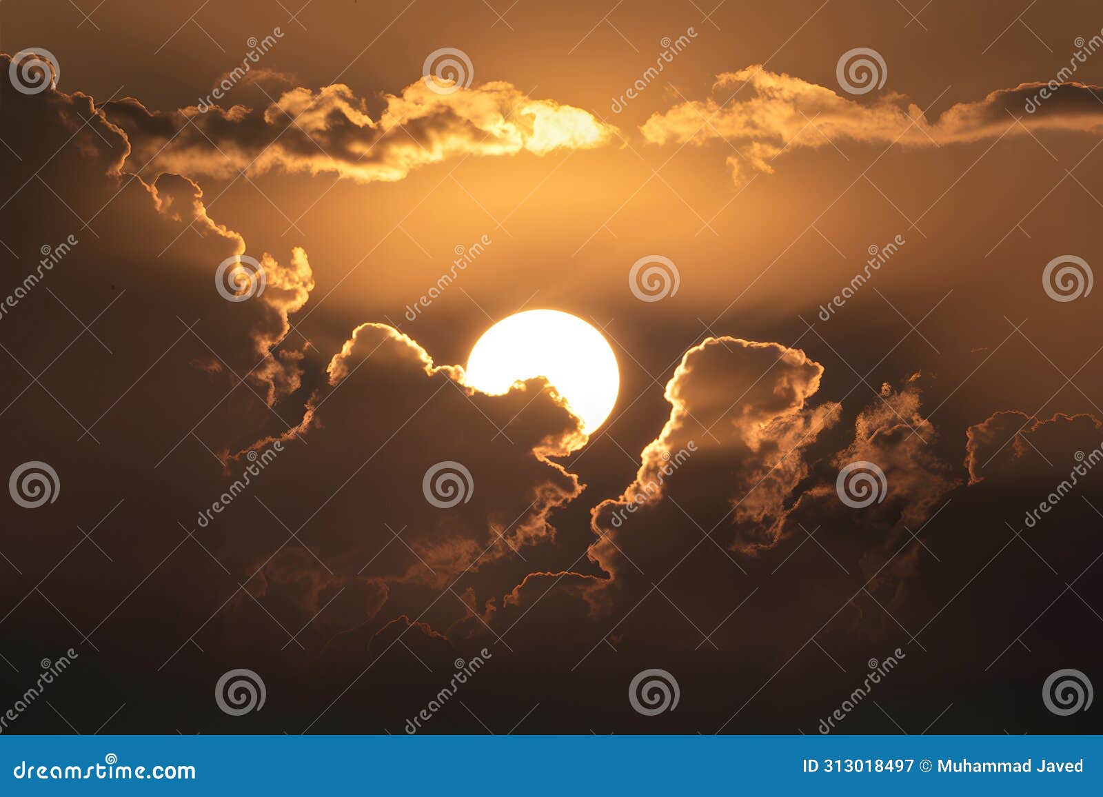 Sun Disk Peeks Out from Behind Dramatic Backlit Clouds Stock ...