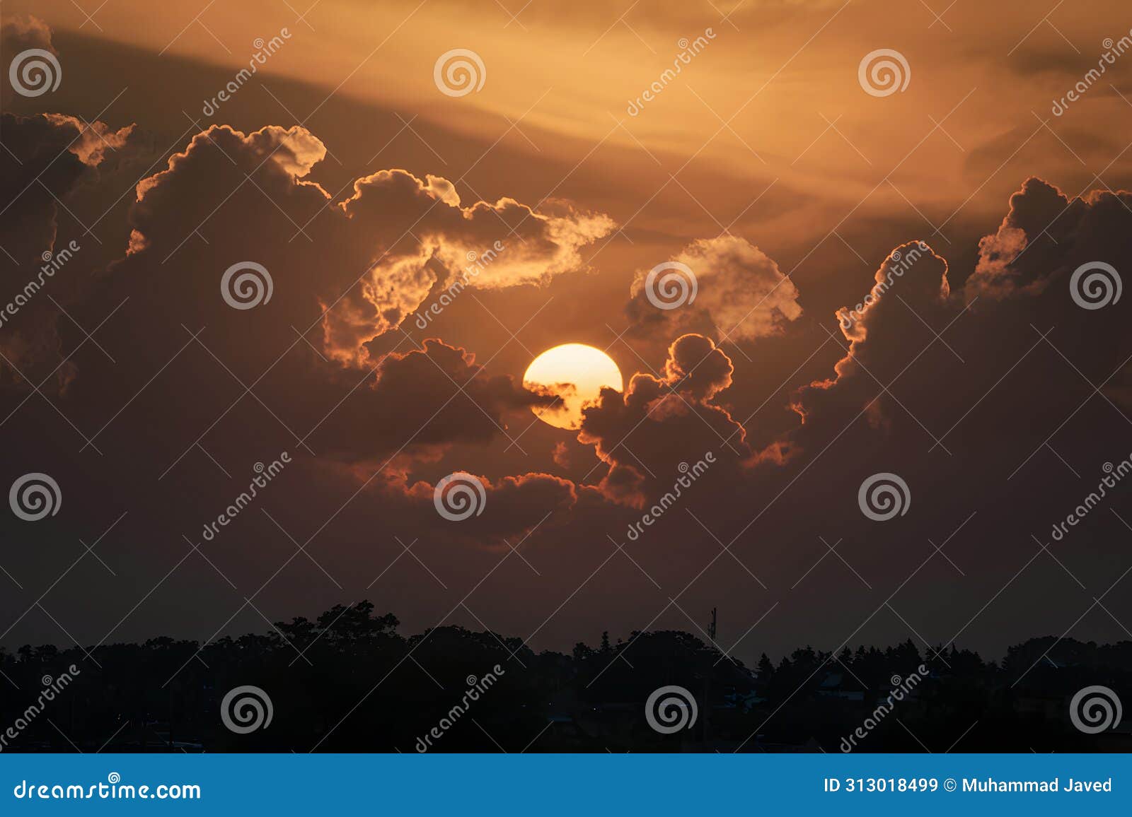 Sun Disk Peeks Out from Behind Dramatic Backlit Clouds Stock ...