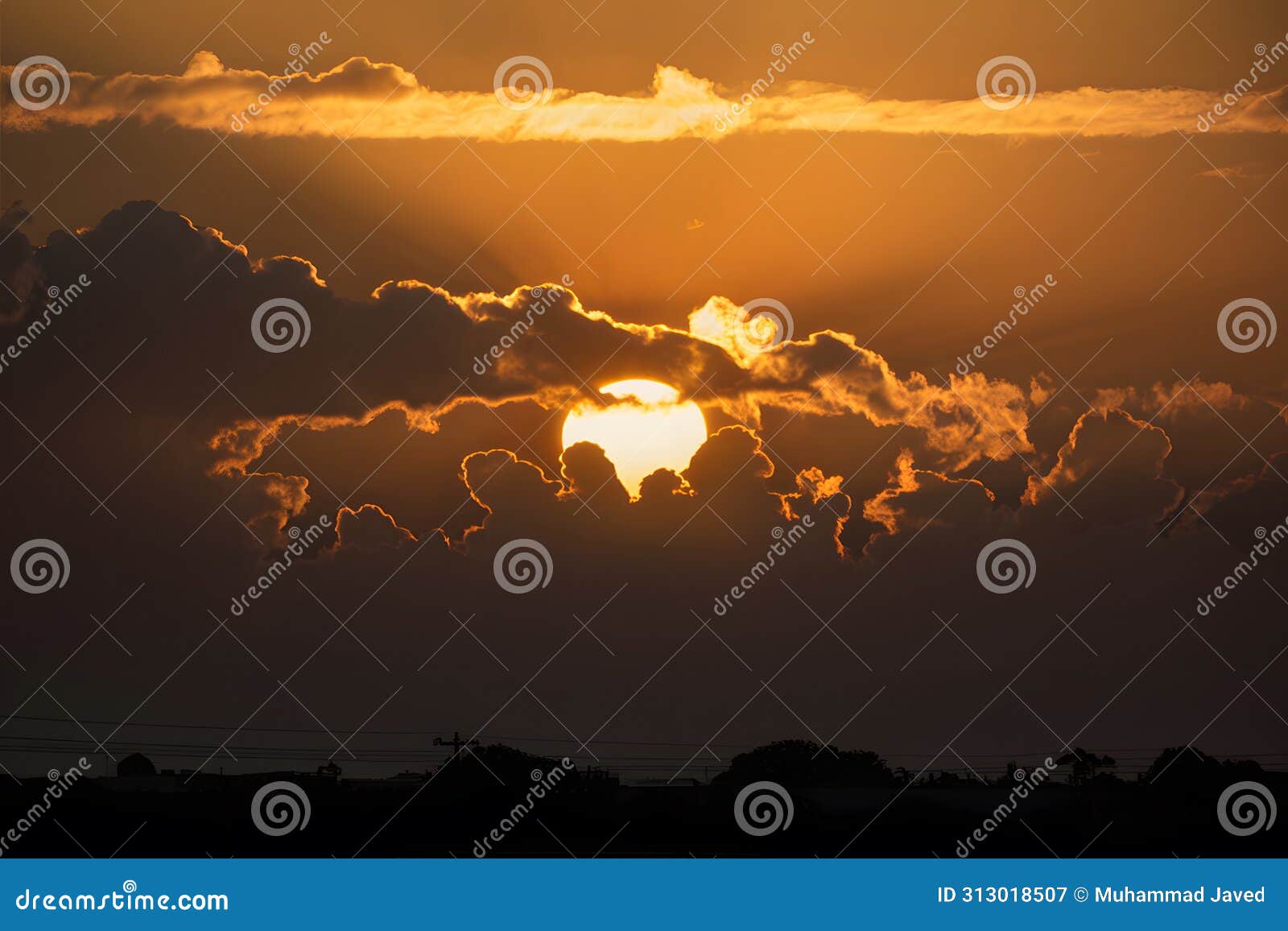 Sun Disk Peeks Out from Behind Dramatic Backlit Clouds Stock ...