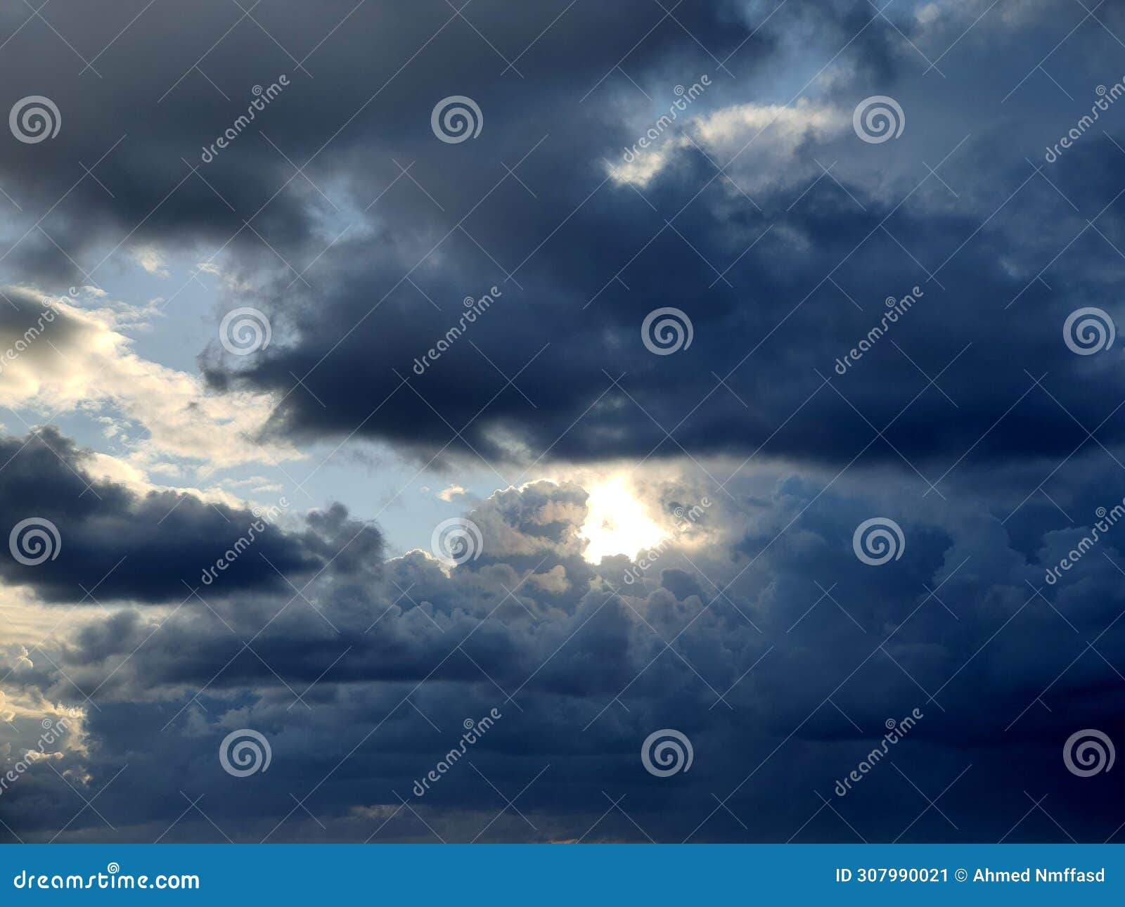 Sun Hidden by Heavy Grey Clouds into Blue Sky Stock Image - Image of ...