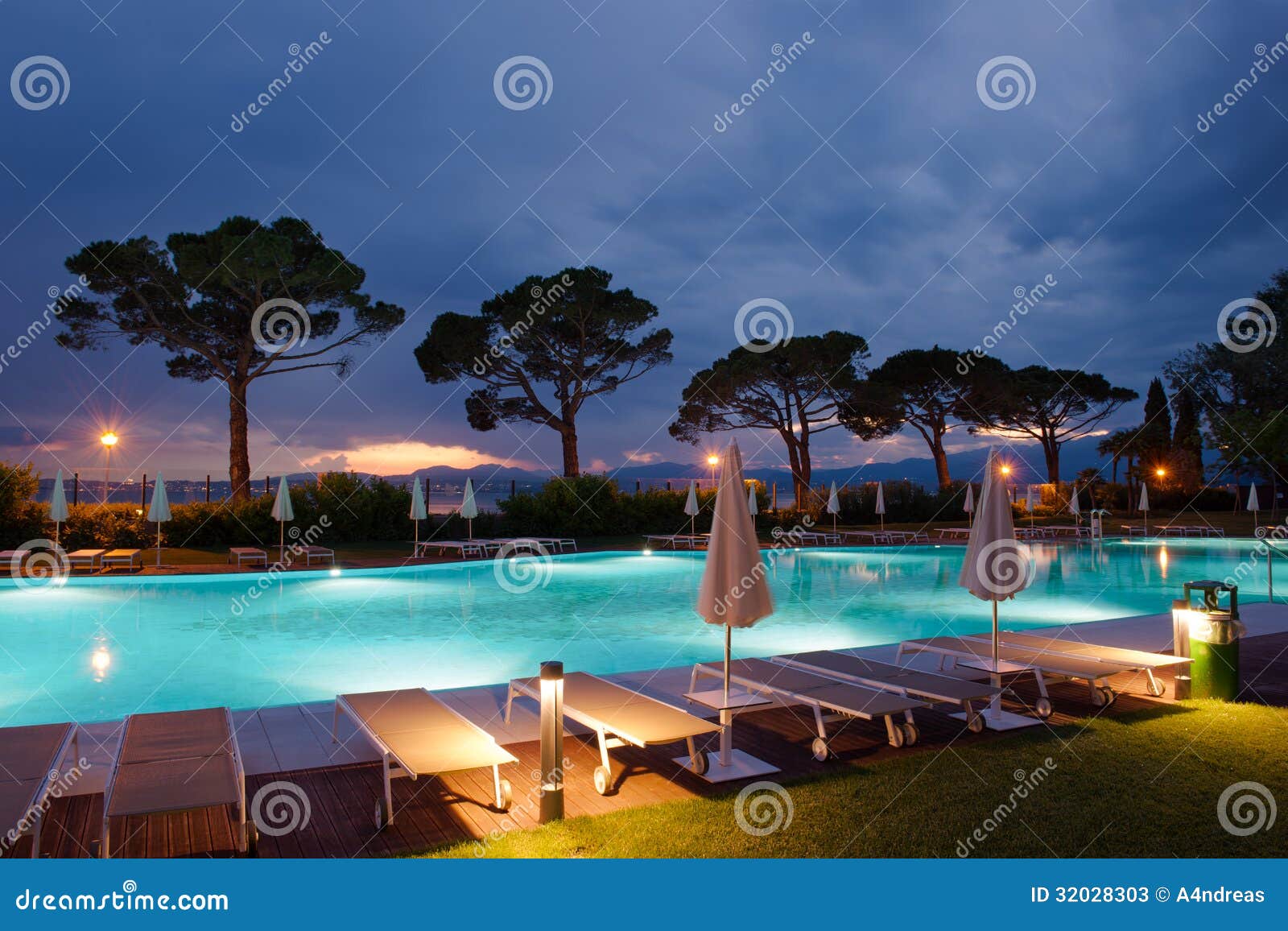 Sun loungers on poolside stock image. Image of dusk, night - 32028303