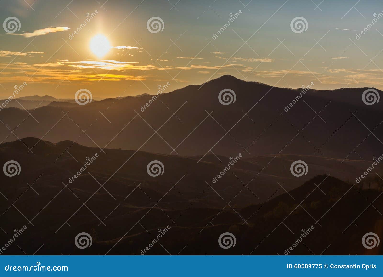 Sun Low Over Silhouette of Landscape Stock Image - Image of silhouetted ...