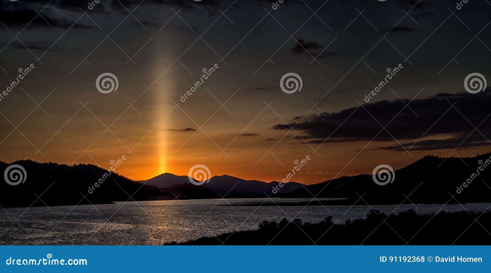 Sun Pillar at Sunset Overlooking a Lake in Horizontal Orientation Stock ...
