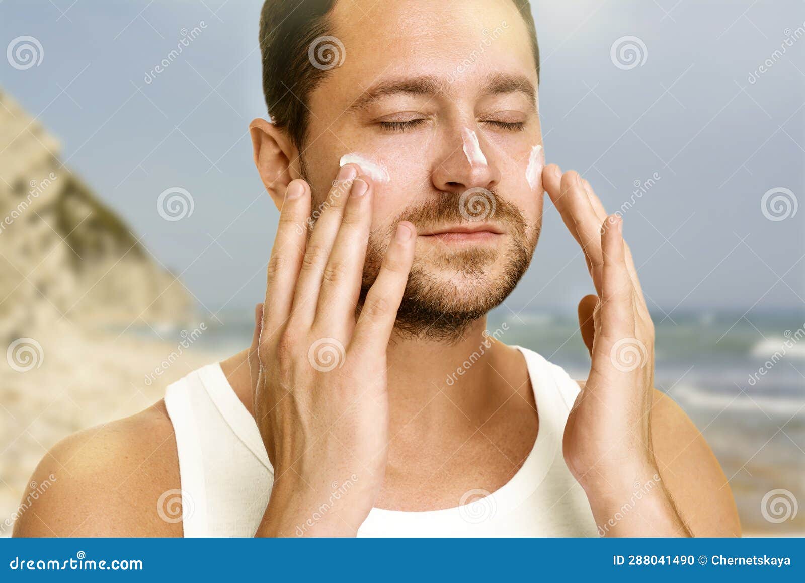 Sun Protection. Man Applying Sunblock Onto Face on Beach Stock Photo ...