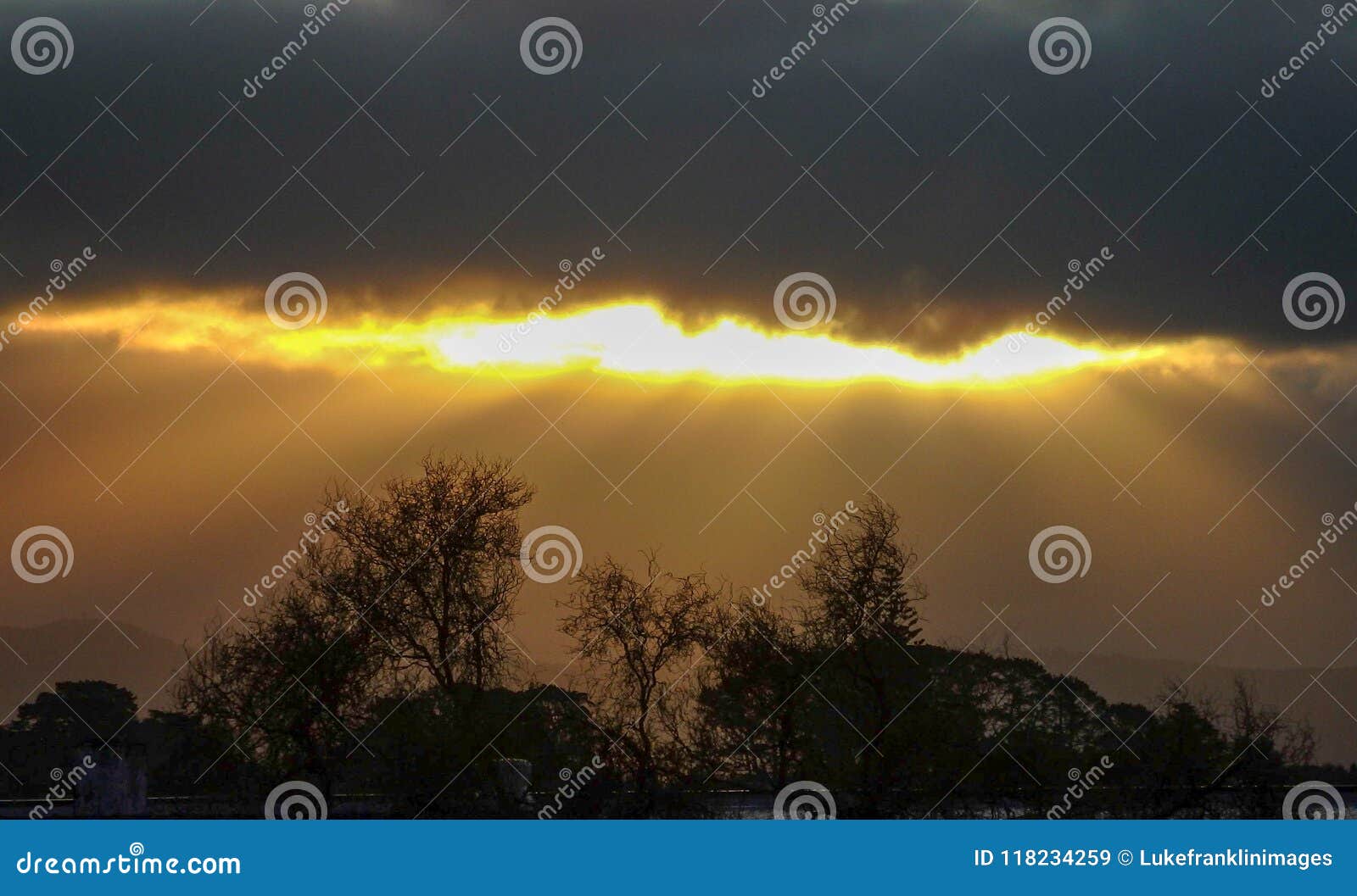 Sun Rays Beaming through a Dark Cloud Stock Image - Image of glow ...