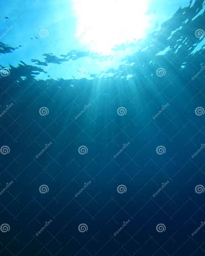 Sun rays in blue water stock image. Image of bright, beam - 15075797