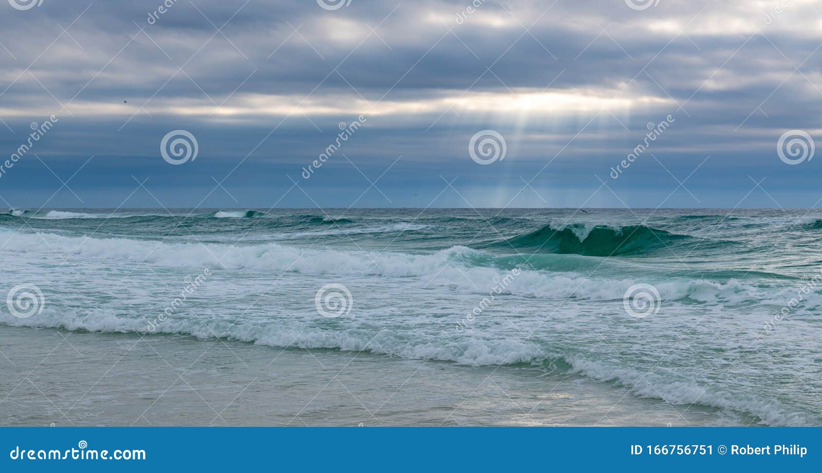 Sun Rays Break the Clouds of a Passing Rain Storm Stock Image - Image ...