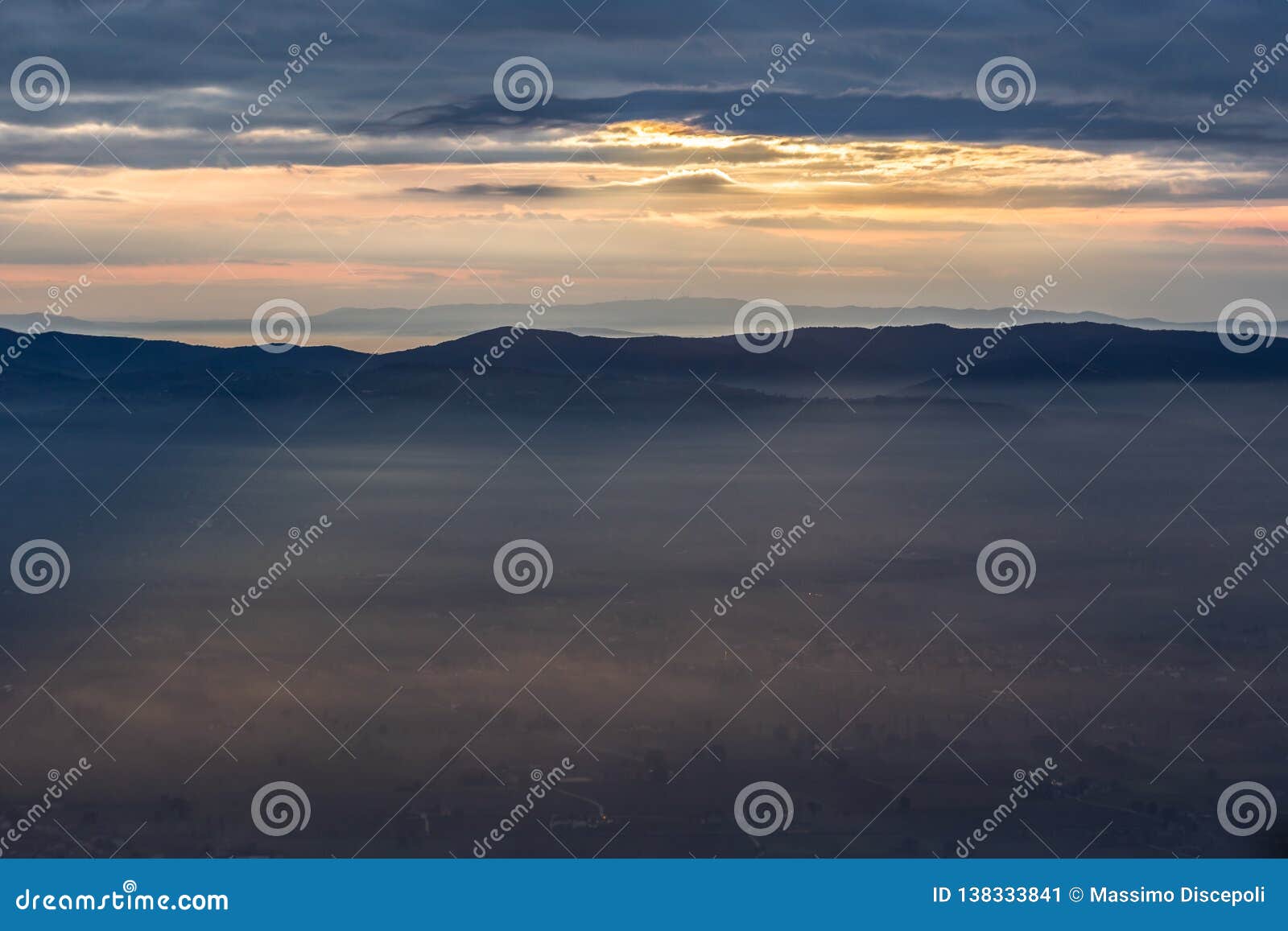 Sun Rays Coming Down from Some Clouds Over a Valley Filled by Fog ...