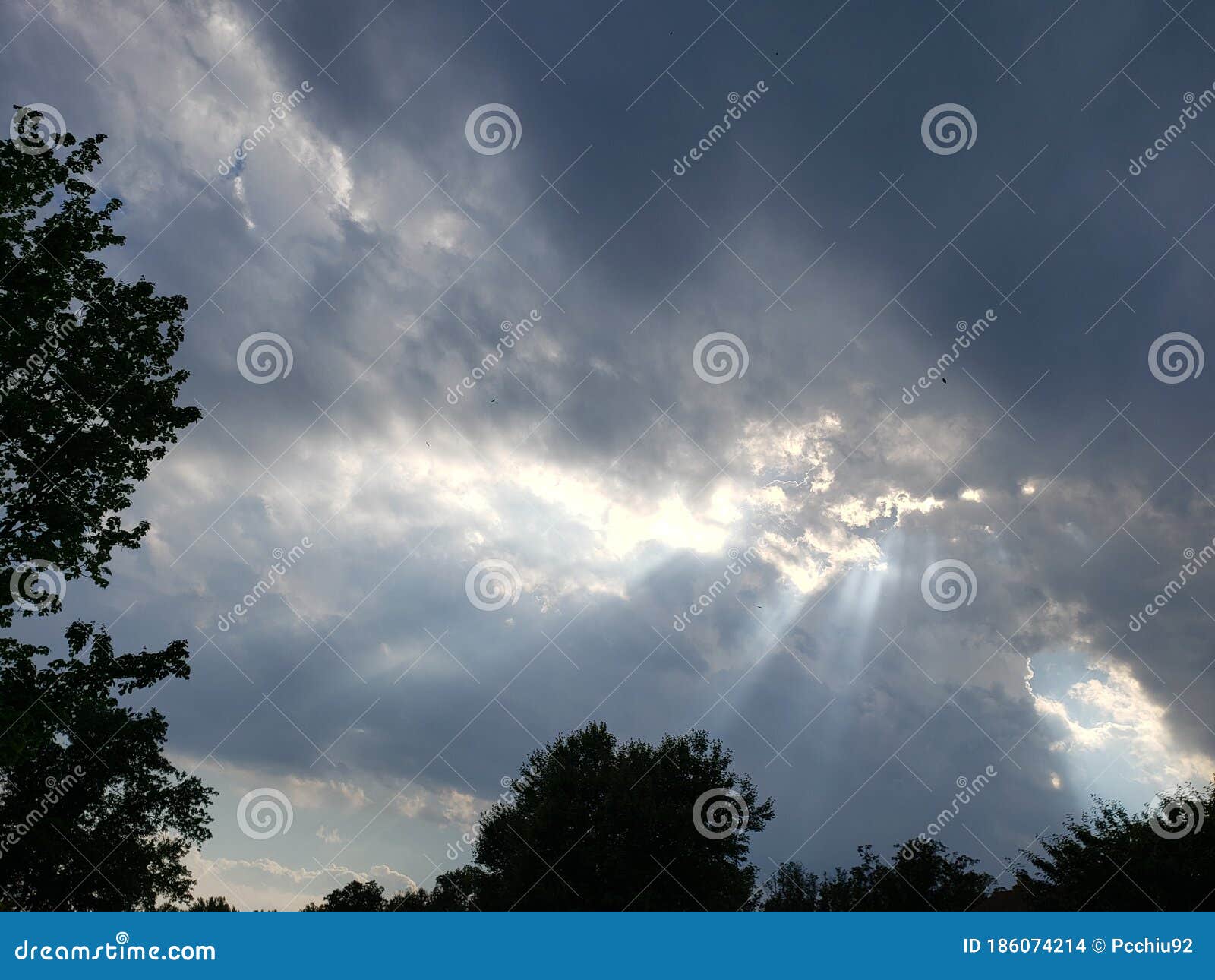 Sun rays from heaven stock photo. Image of moment, houses - 186074214