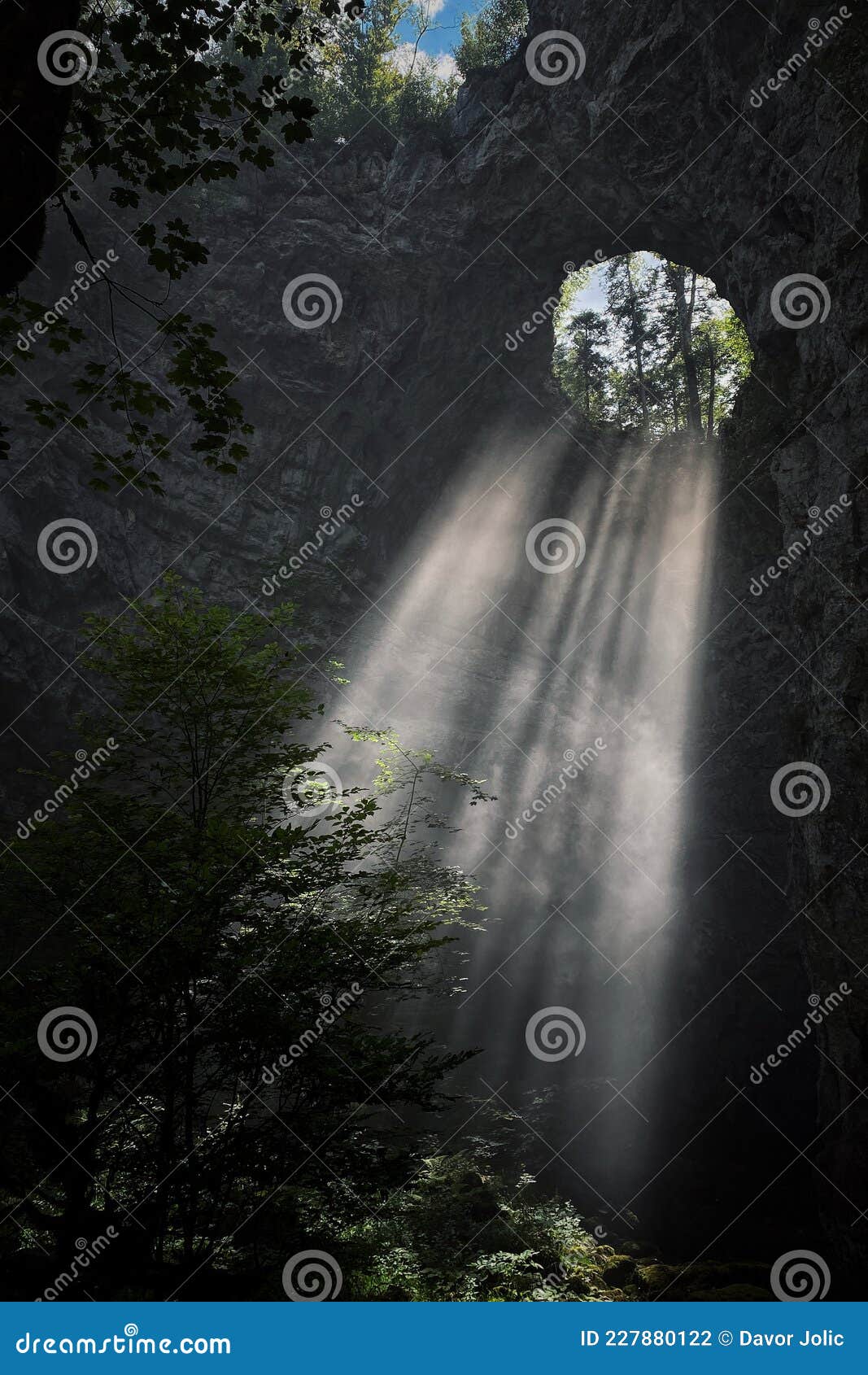 Sun rays through hole stock photo. Image of wilderness - 227880122