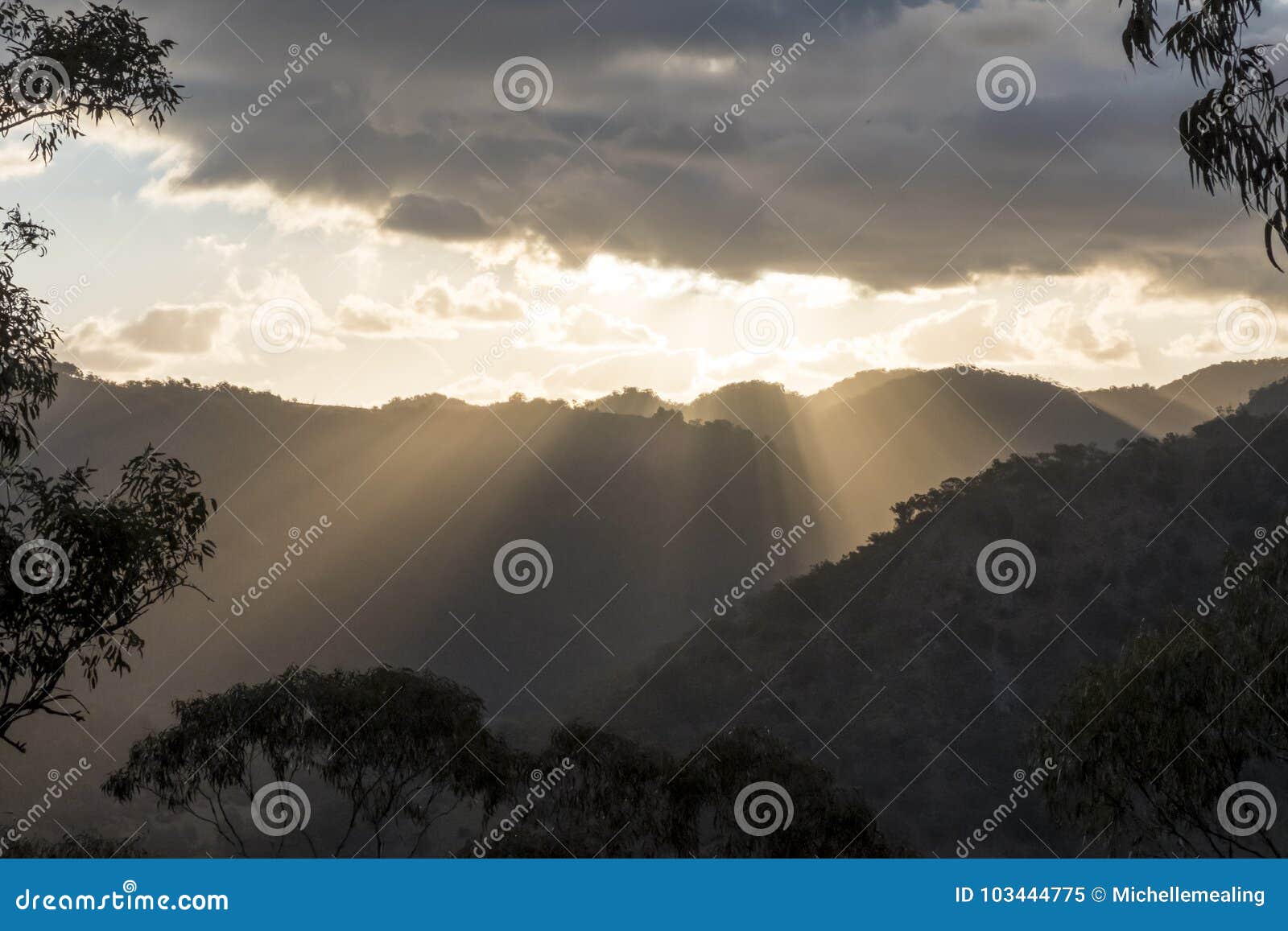 Sun Rays Peaking Over a Southern Highland`s Mountain Range at Sunset ...