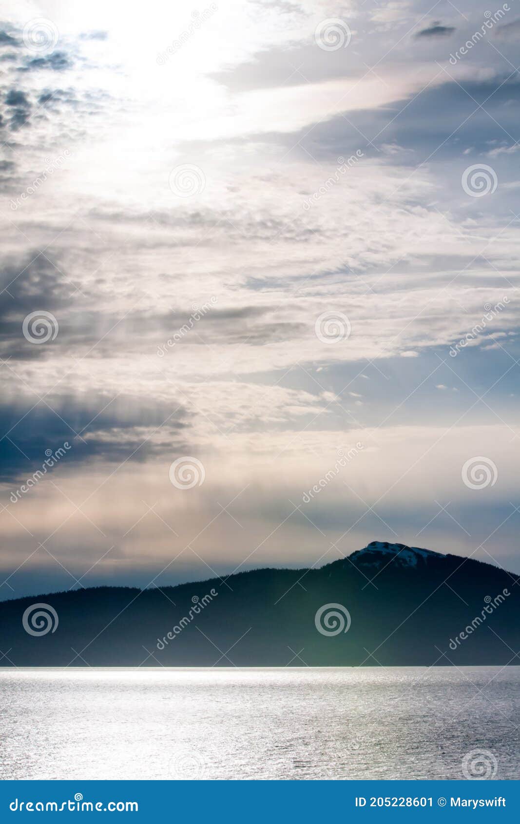 Sun Rays Peeking through Clouds Along the Coast of Alaska Stock Image ...