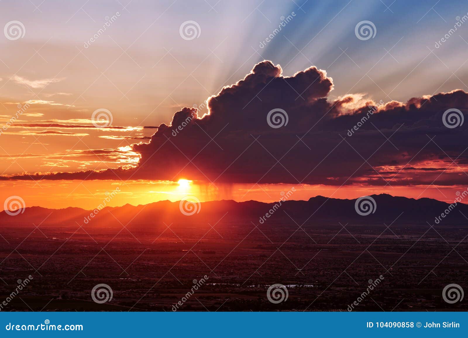 Sun Rays Shine Behind a Cumulus Cloud at Sunset Stock Photo - Image of ...