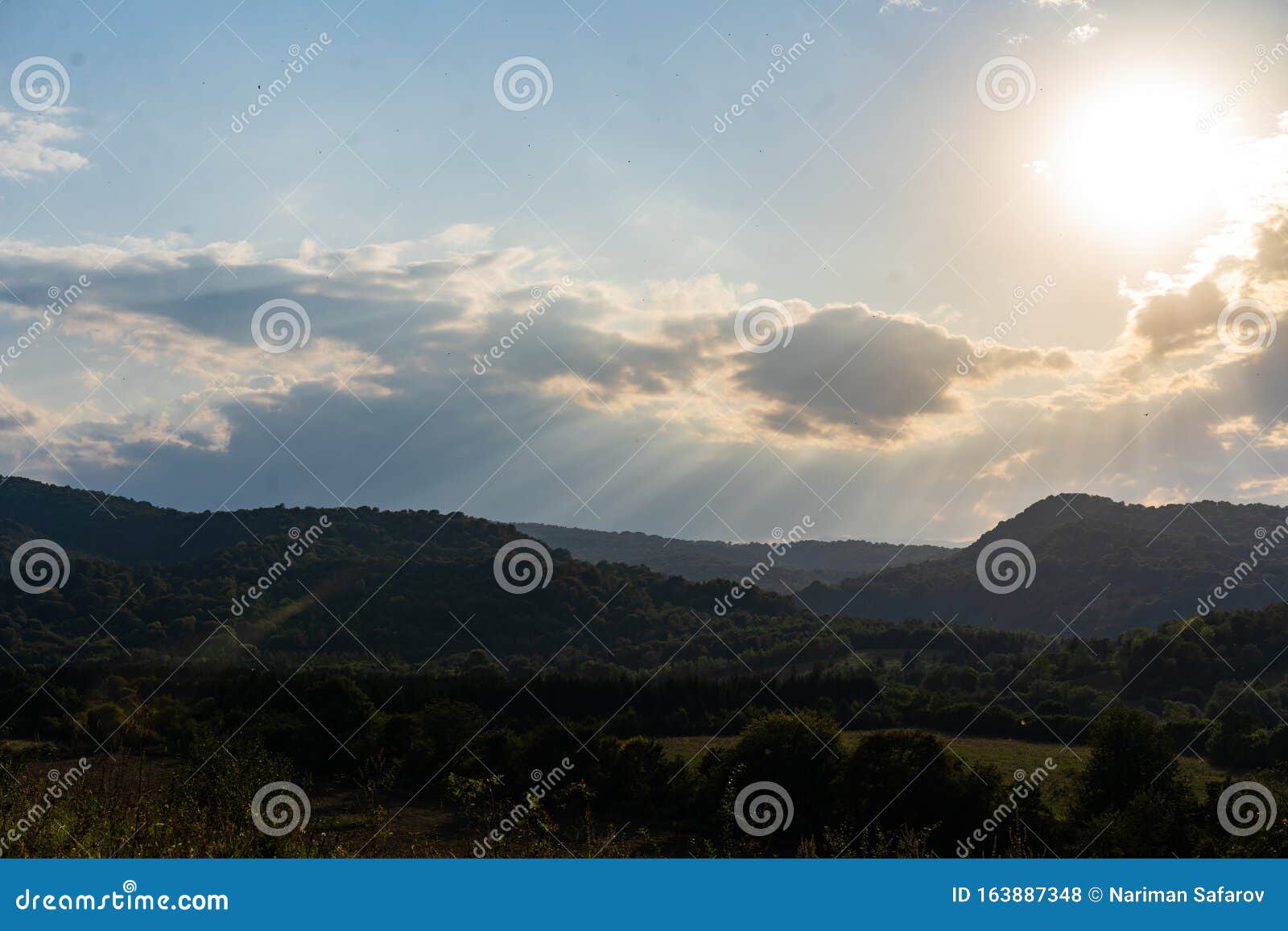 Sun Rays Shine through the Clouds in the Mountains Stock Photo - Image ...