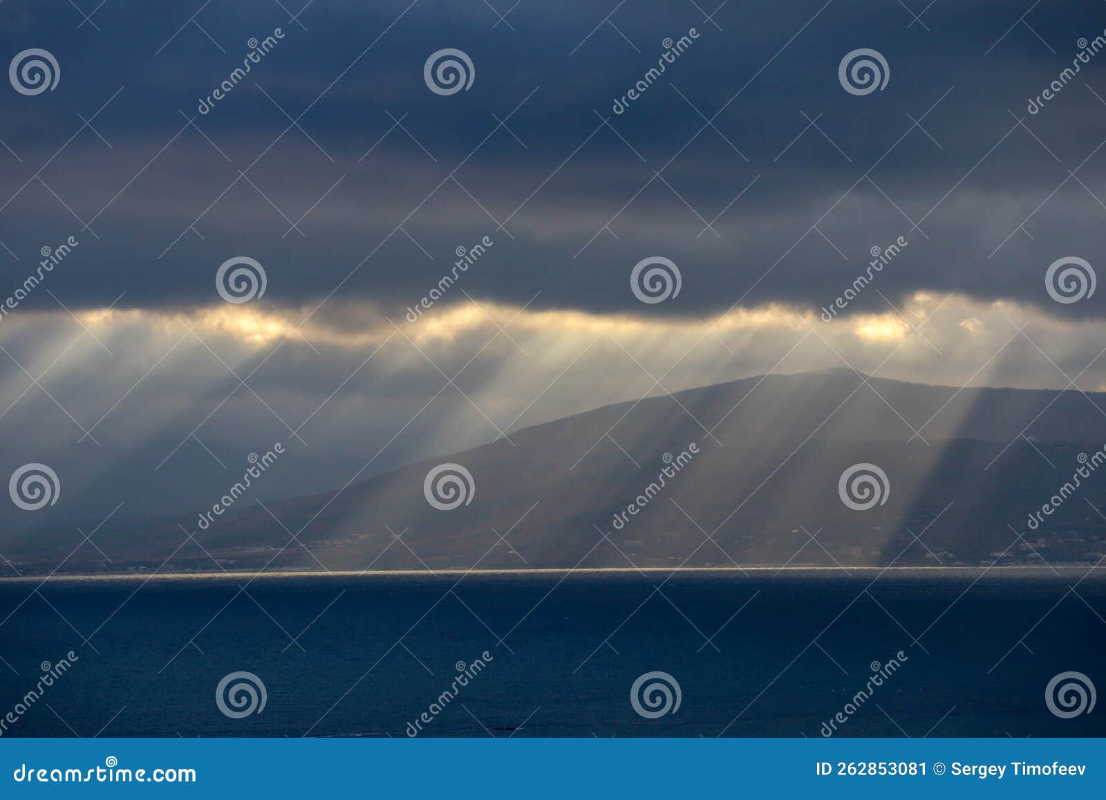 The Sun Rays Shine through the Clouds on the Sea Surface Stock Image ...