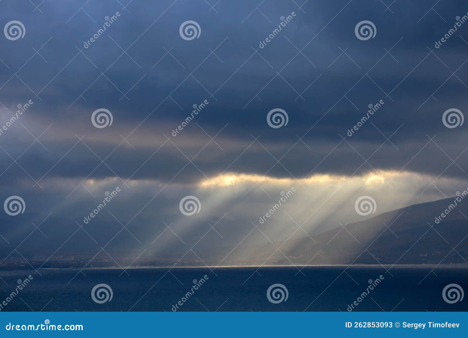 The Sun Rays Shine through the Clouds on the Sea Surface Stock Image ...