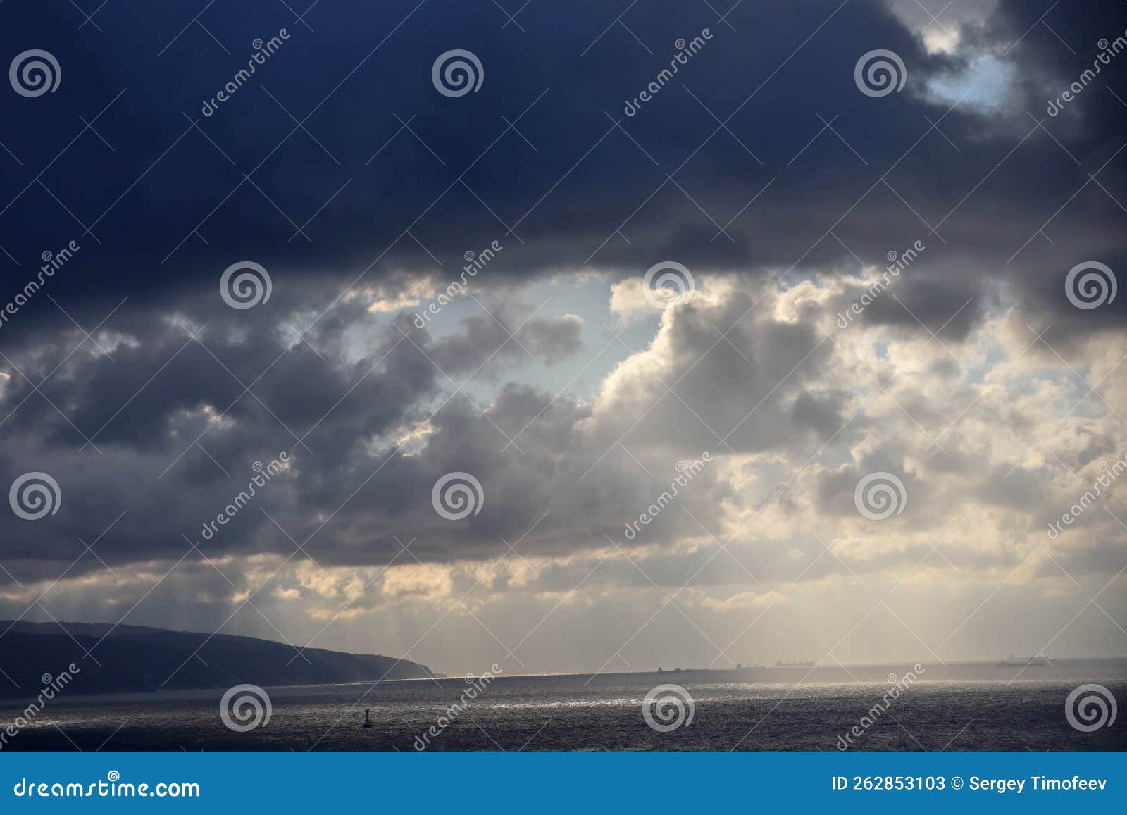 The Sun Rays Shine through the Clouds on the Sea Surface Stock Image ...