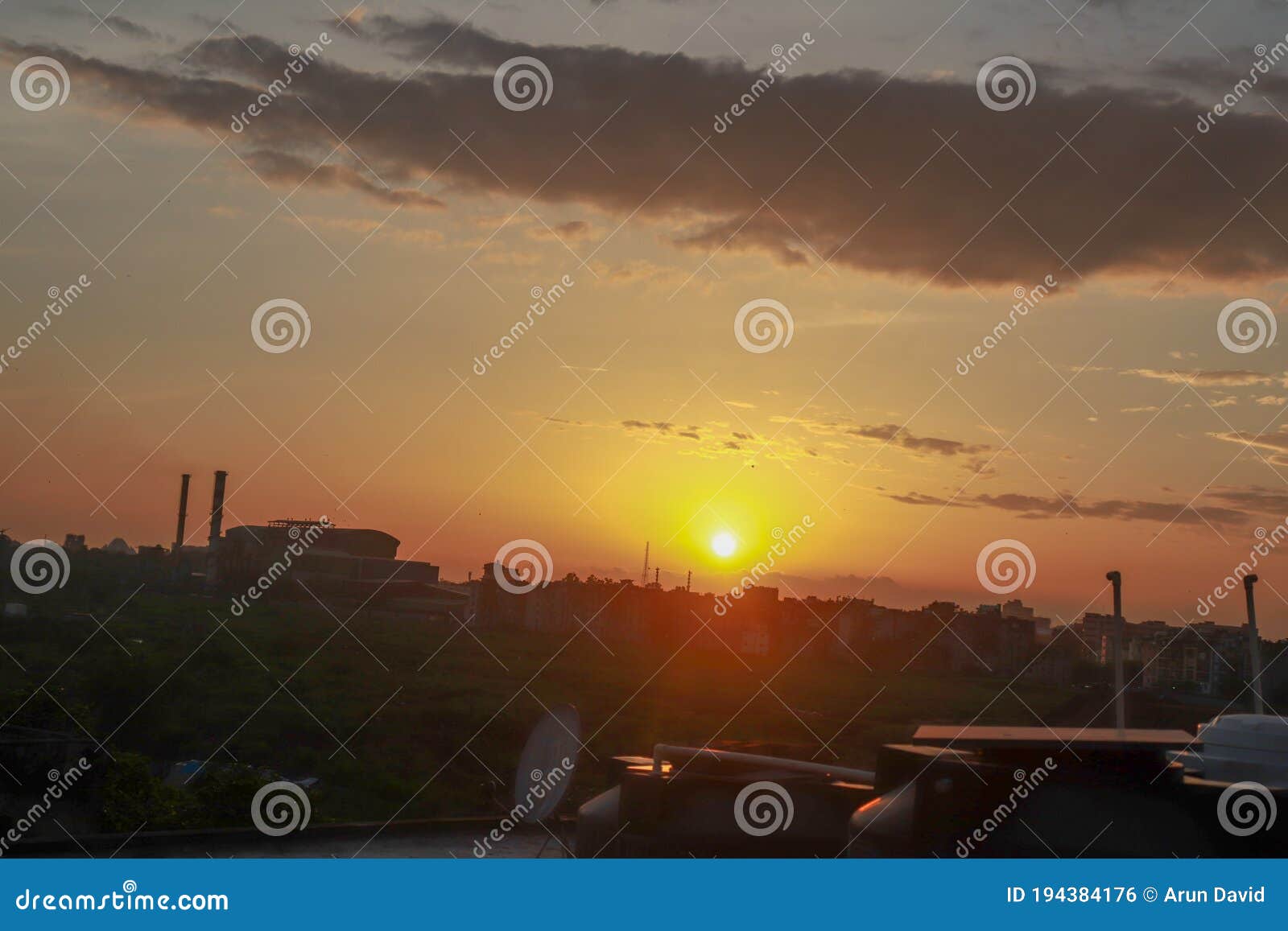 Sun Rays Shining through the Clouds Behind the Tall Buildings Stock ...