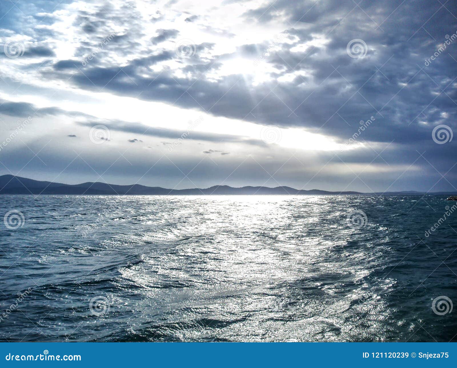 Sun rays shinning on a sea stock image. Image of environment - 121120239