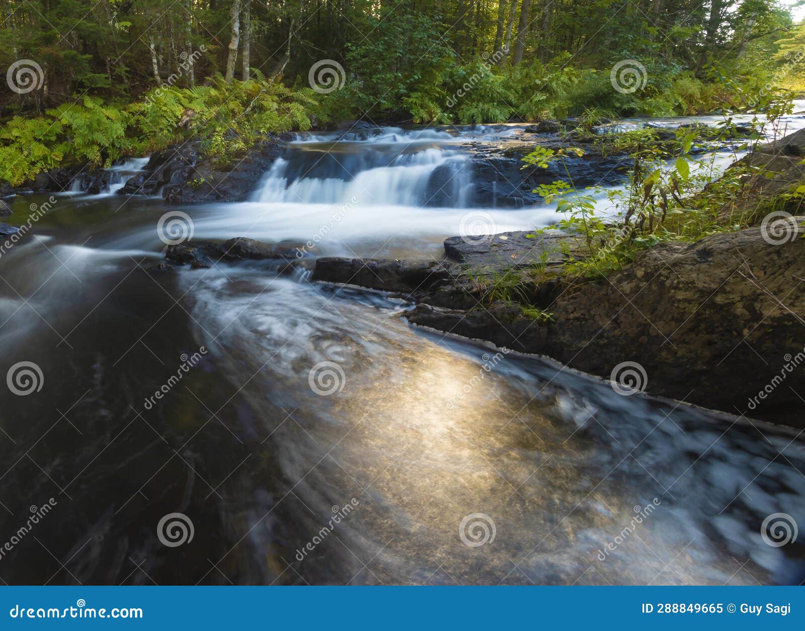 Sun Reflecting Off a Pool of Water Below a Waterfall Stock Image ...