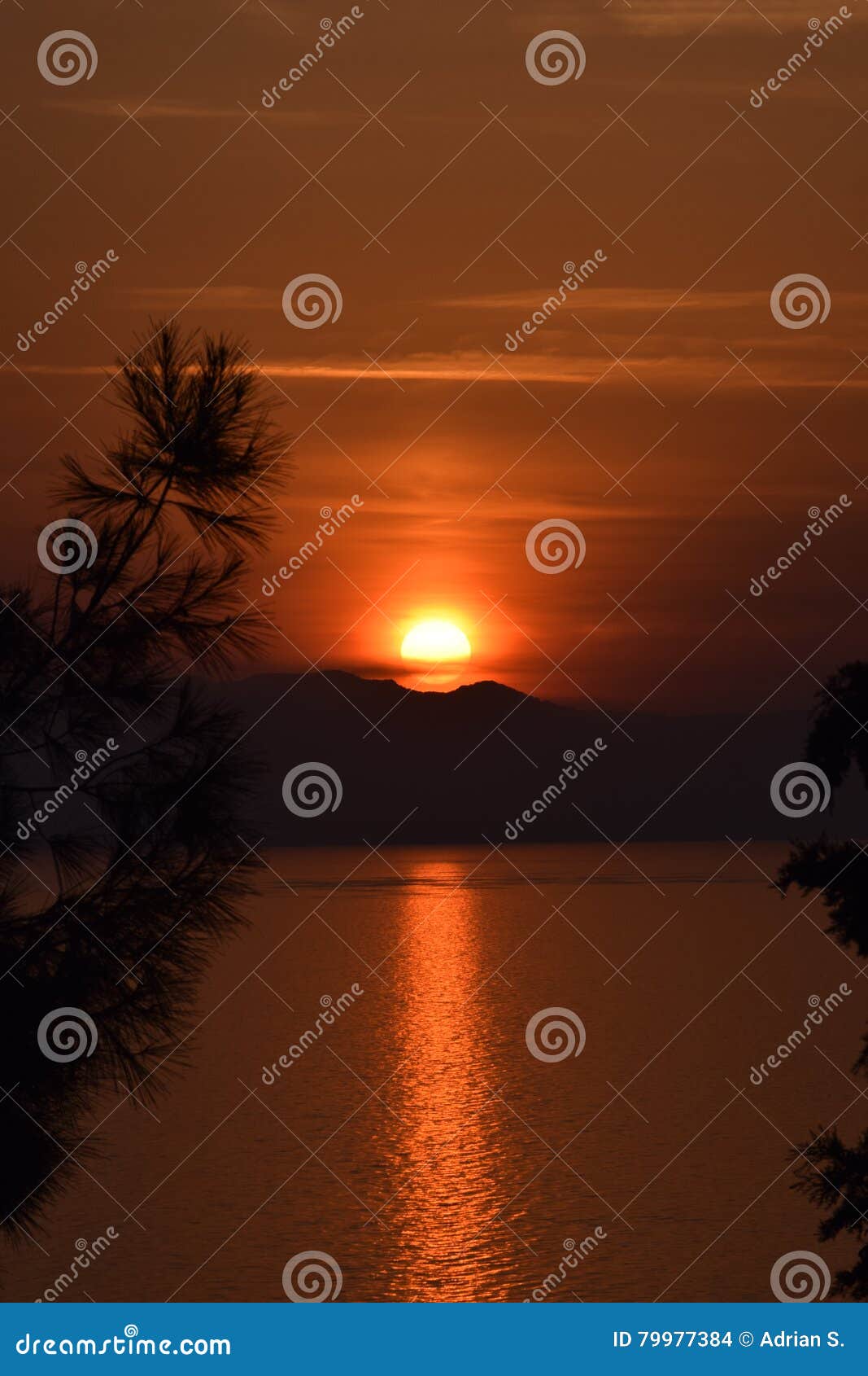 Sun Rising Behind the Mountains. Reflection into the Sea Stock Photo ...