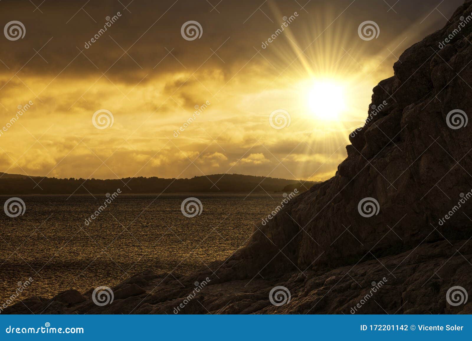 The Sun Rising Behind the Rocks in the Lake Stock Photo - Image of ...
