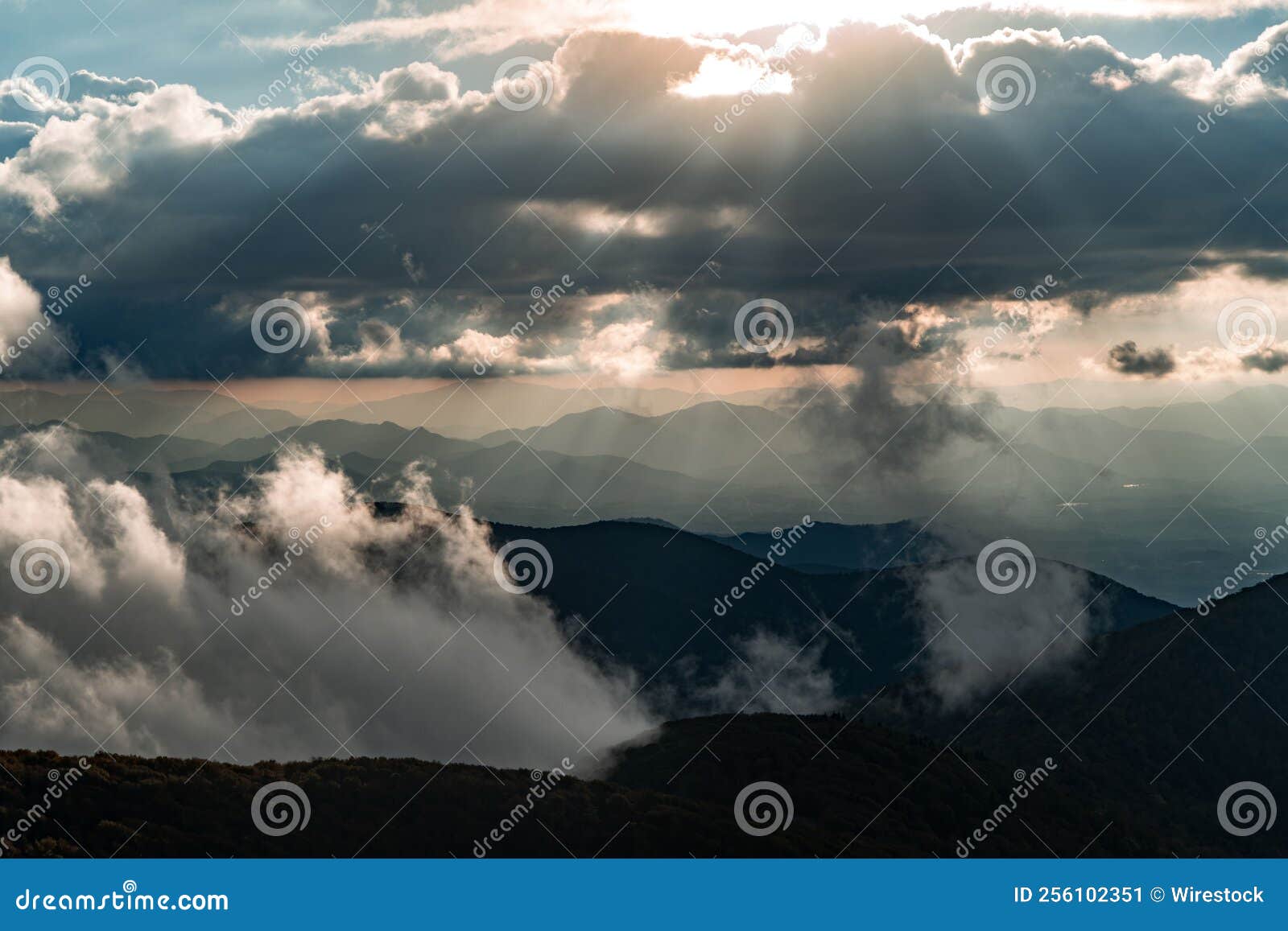 Sun Rising with Clouds in the Sky Over Hills in a Beautiful Valley ...