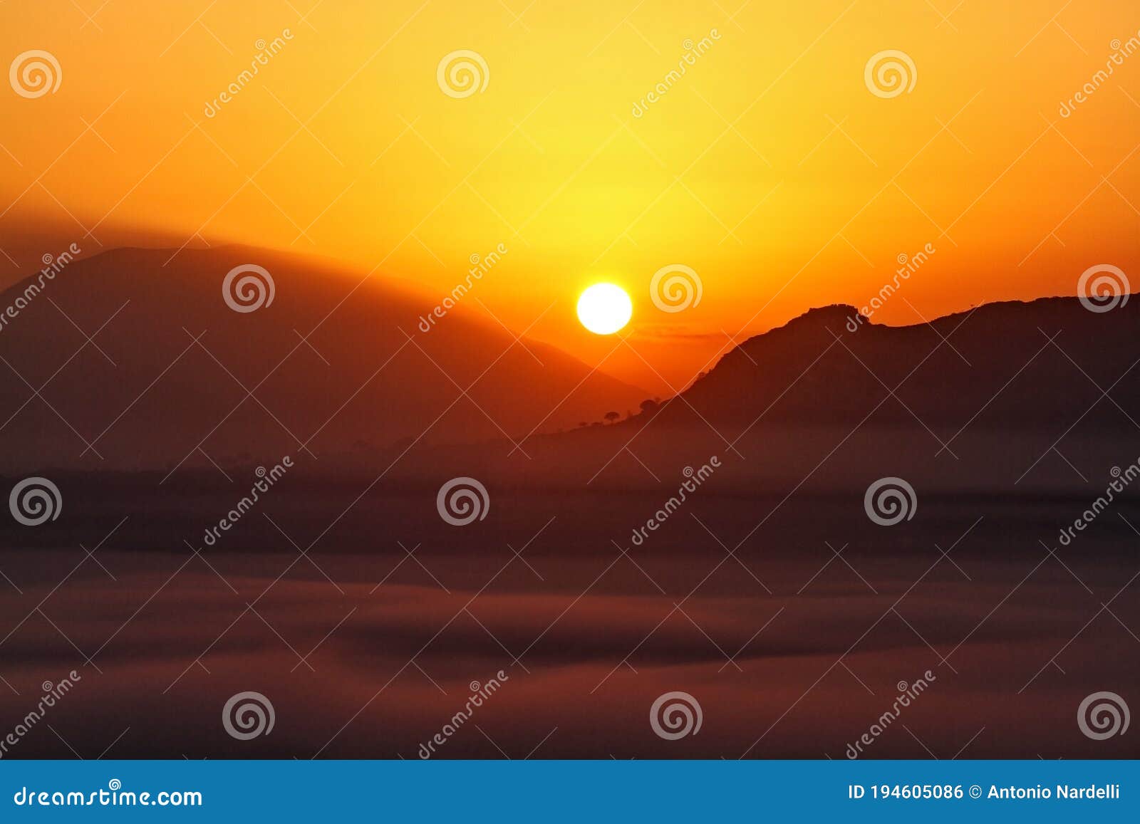 The Sun Rising at Dawn between the Mountains and the Fog Stock Photo ...