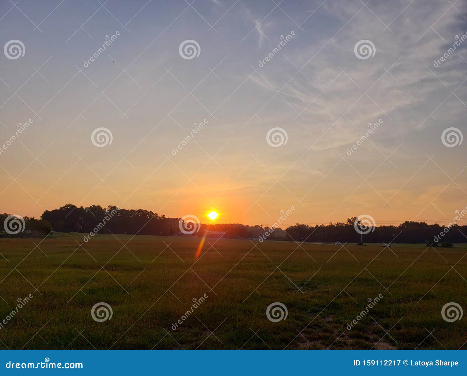 Sun Rising Over a Grassy Field Stock Image - Image of lake, nature ...