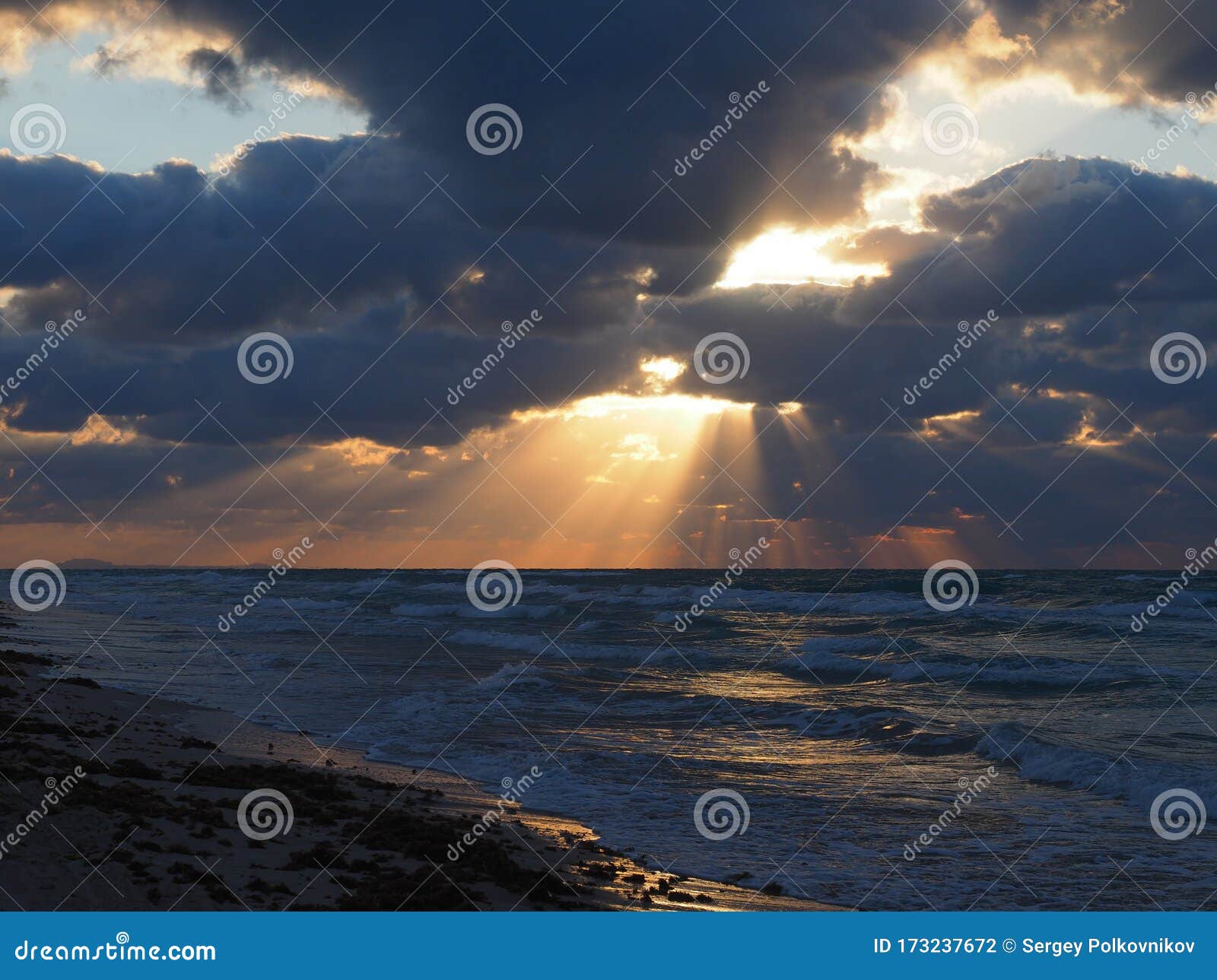 The Sun`s Rays Break through the Clouds Over the Sea Stock Photo ...