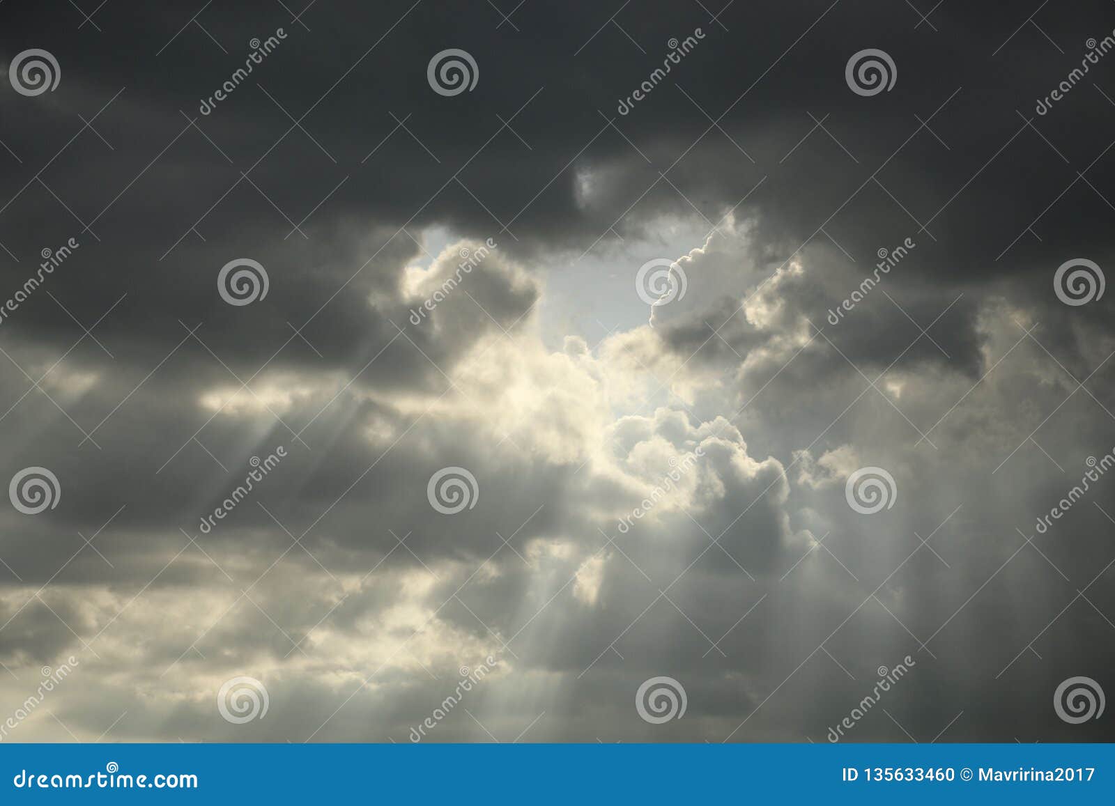 The Sun`s Rays Breaking through the Dark Rain Clouds Stock Photo ...