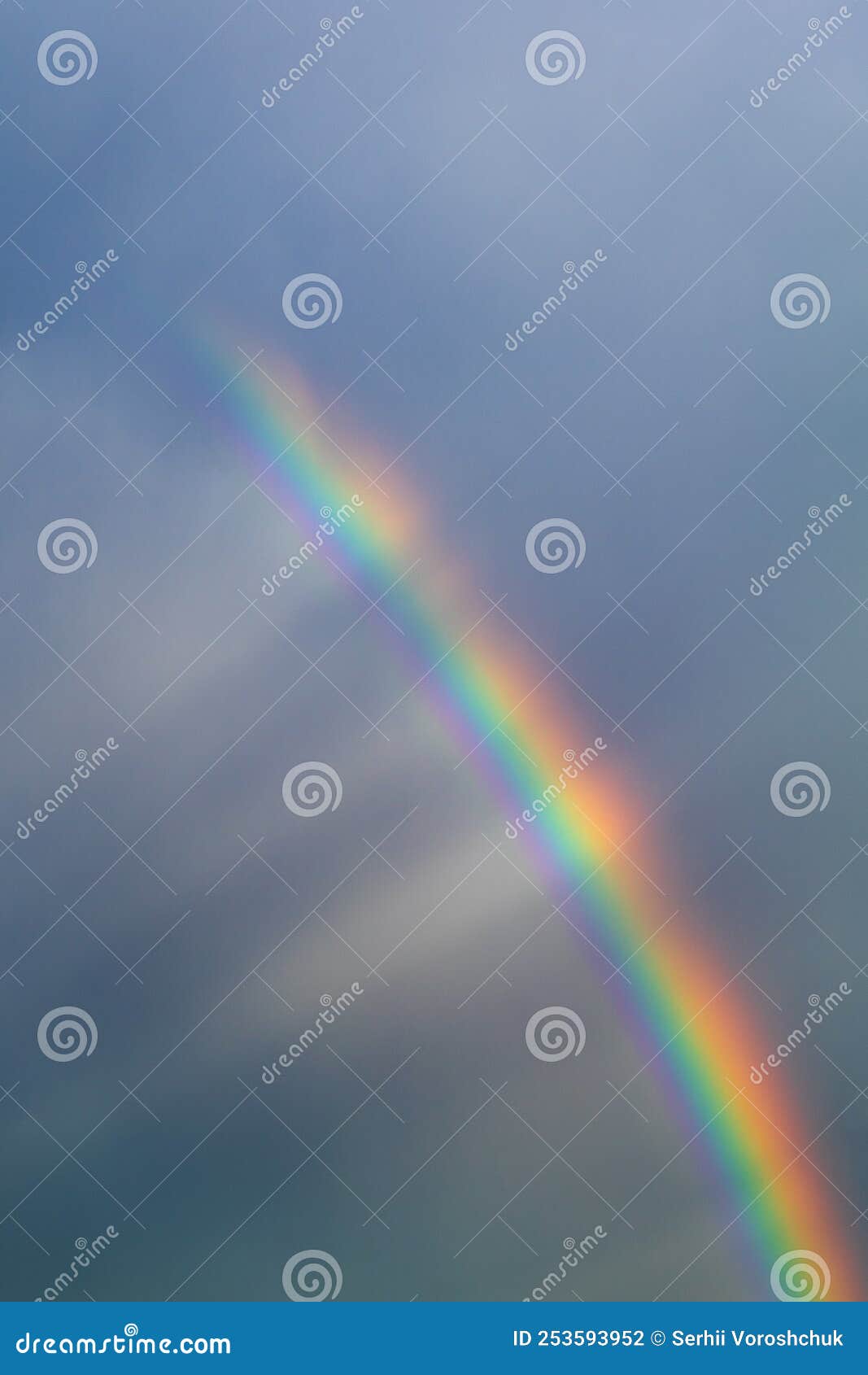 The Sun S Rays Shine on a Multi-colored Rainbow from Behind the Clouds ...