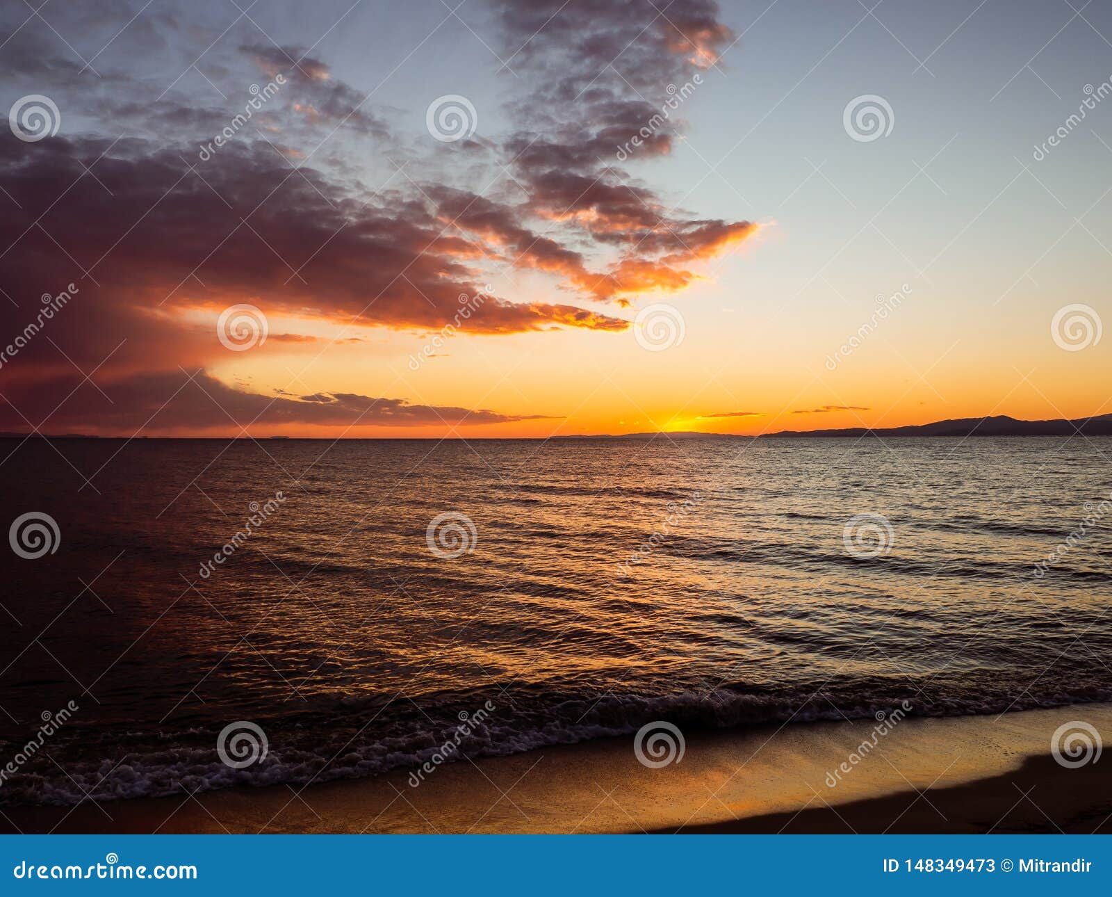 Sun Set Over the Horizon - Beautiful Empty Beach - Small Waves Stock ...