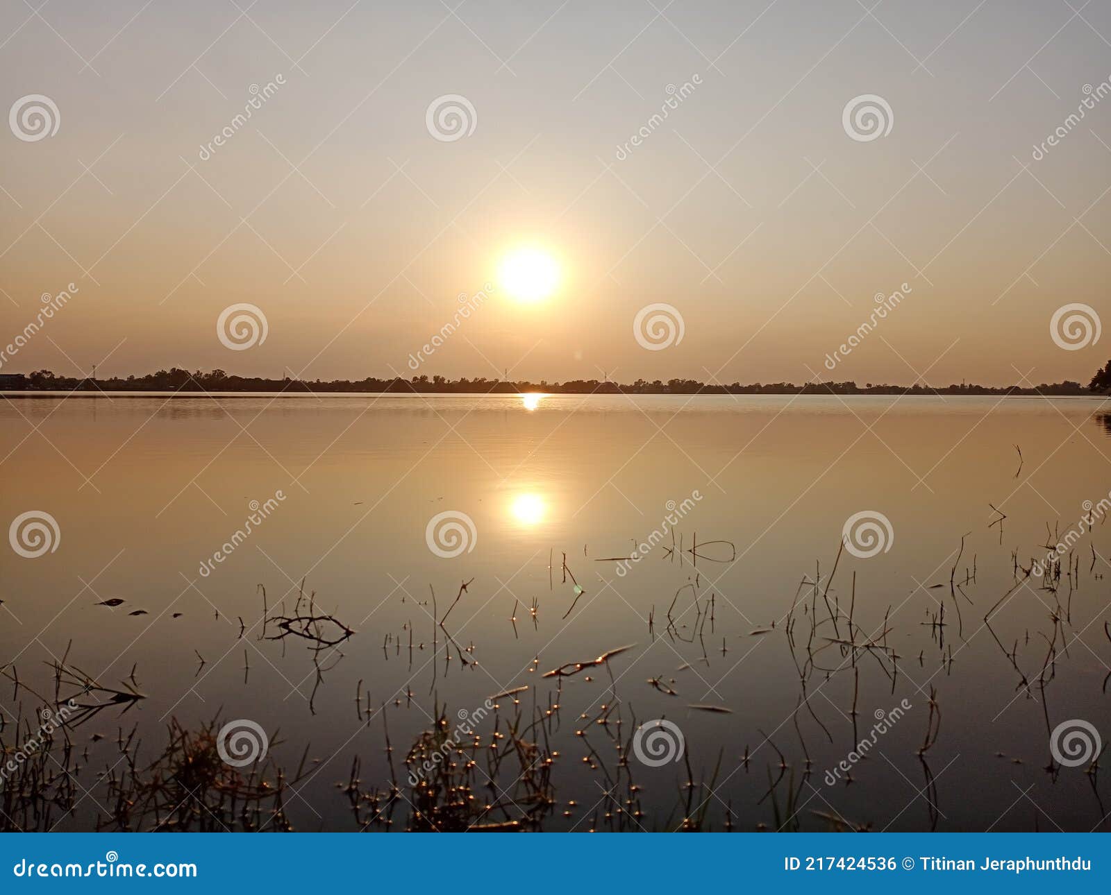 Sun set over lake stock photo. Image of dawn, cloud - 217424536