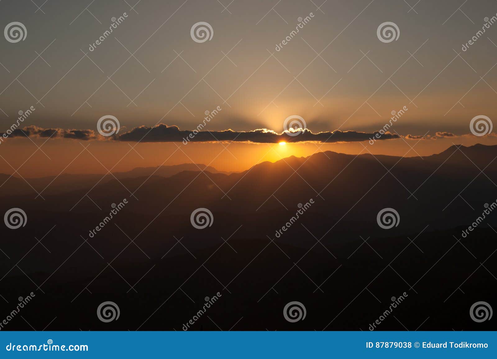 Sun Setting Behind the Clouds and Mountains. Stock Photo - Image of ...