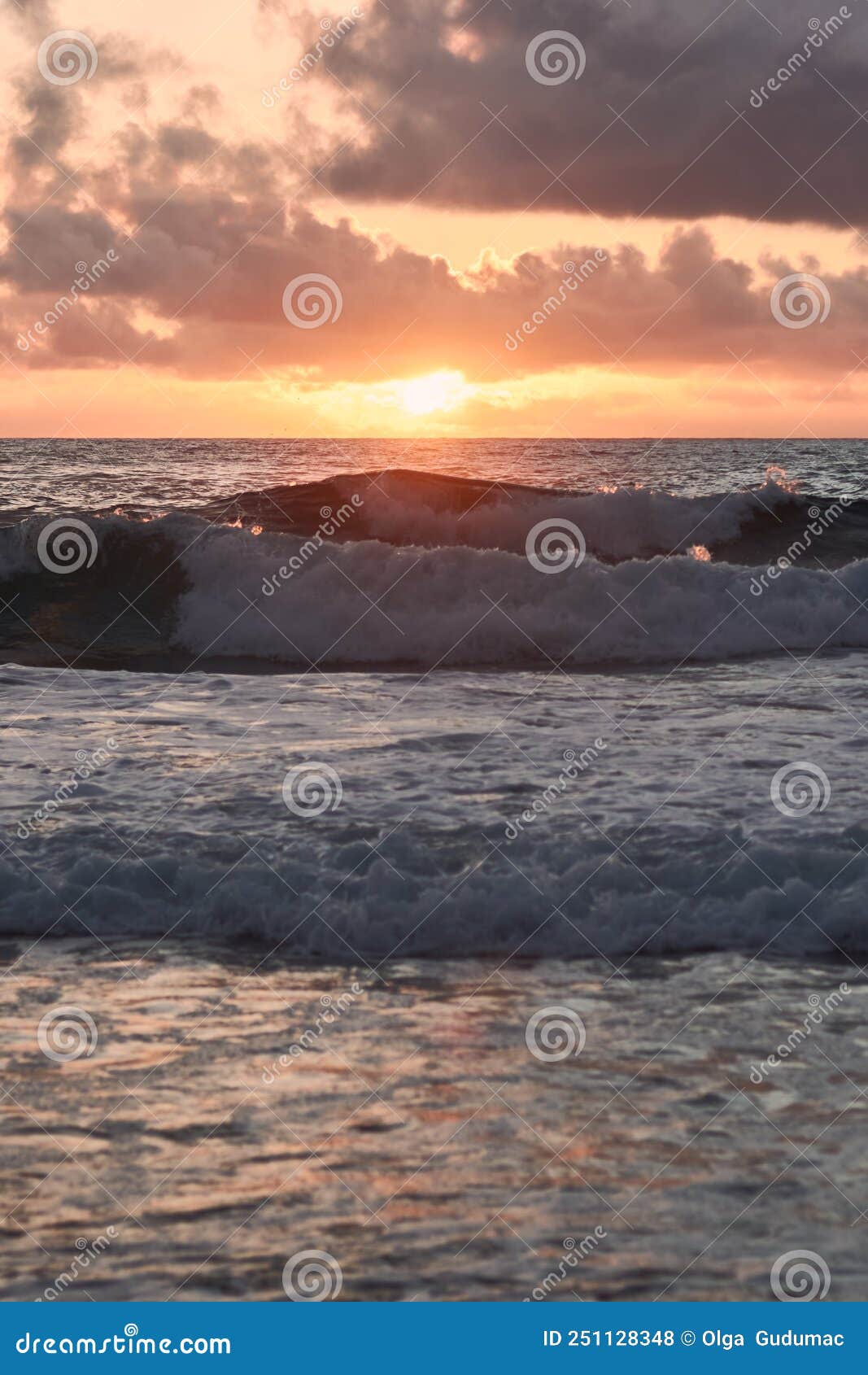Sun Setting Behind the Ocean with Waves on the Foreground Stock Photo ...