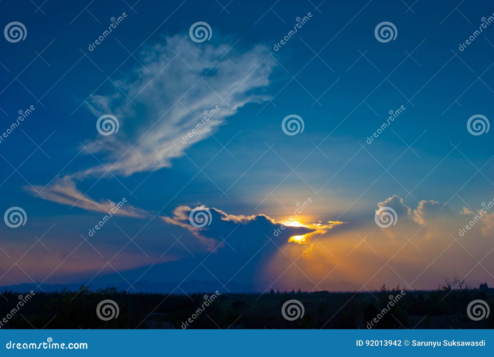 The Sun is Setting Behind the Strange Shape of Cloud Stock Photo ...