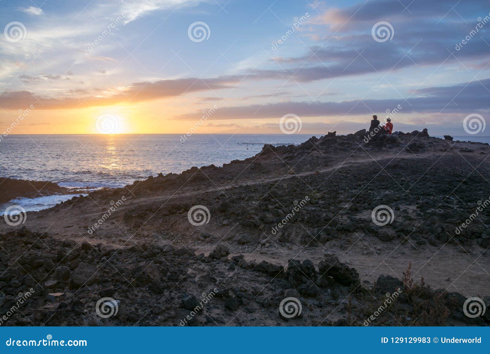 Sun Setting on the Ocean stock image. Image of beach - 129129983