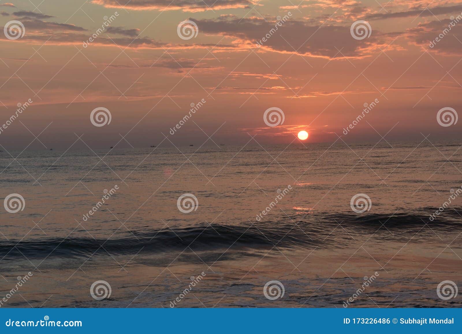 Sun Setting in a Ocean with Small Waves and Beautiful Sky Stock Photo ...