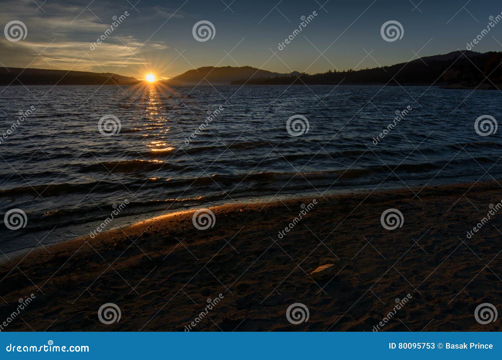 Sun Setting Over Big Bear Lake Lighting Up the Rock on the Beach Stock ...