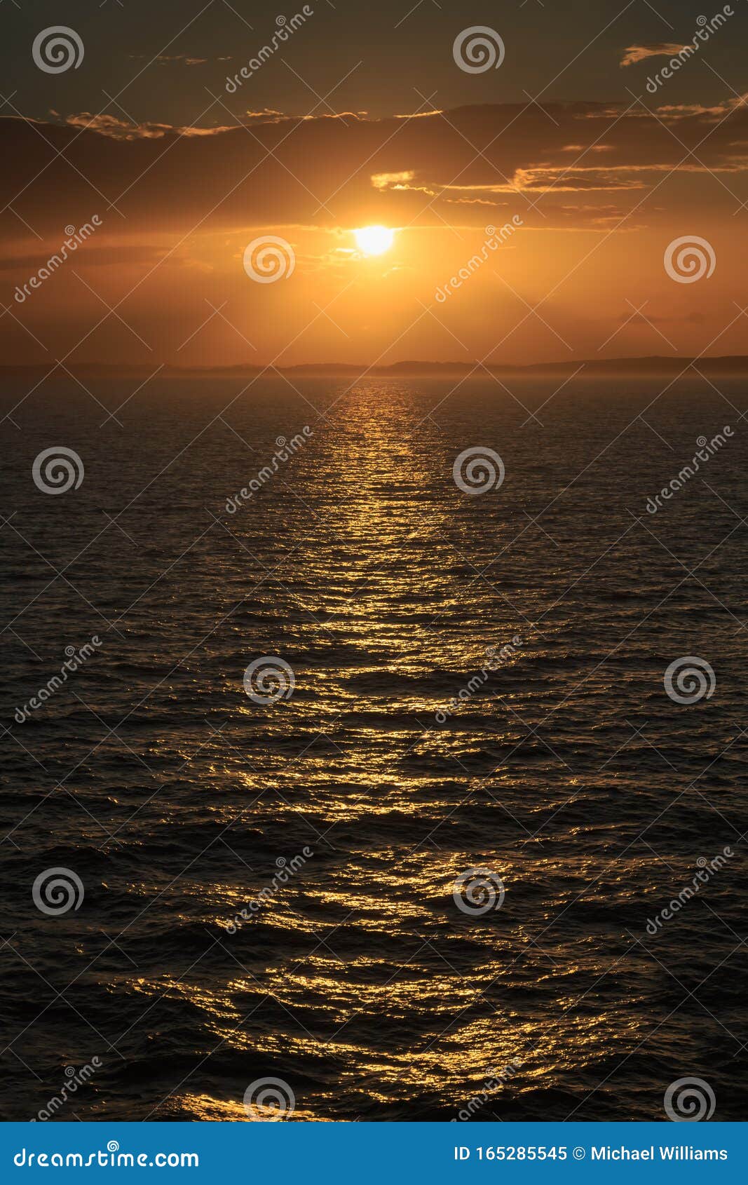 The Sun Setting Over a Darkening Ocean Stock Image - Image of clouds ...