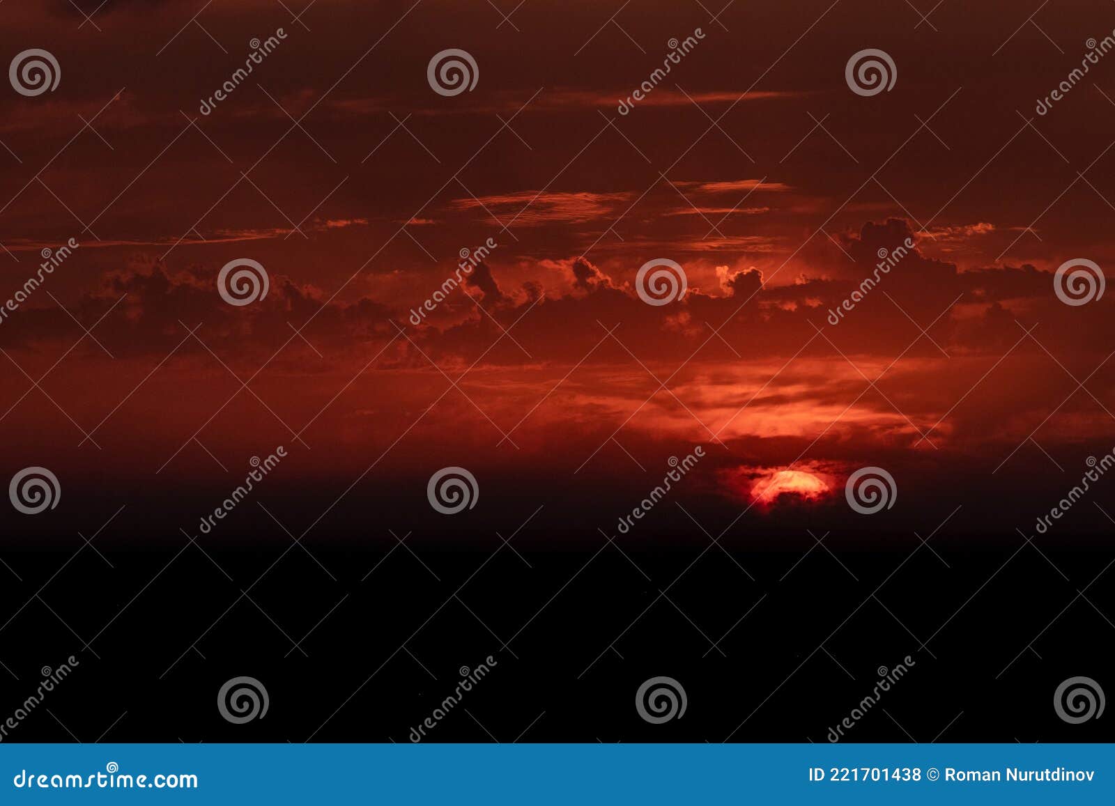 The Sun is Setting Over the Horizon. Beautiful Sunset Stock Photo ...