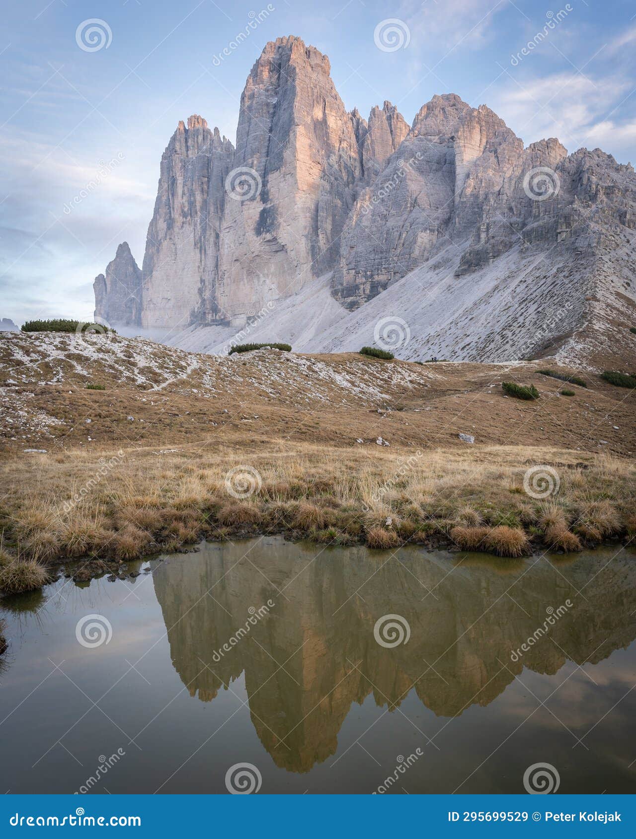 Sun Setting Over Massive Rock Formation of Tre Cime Reflecting in Small ...
