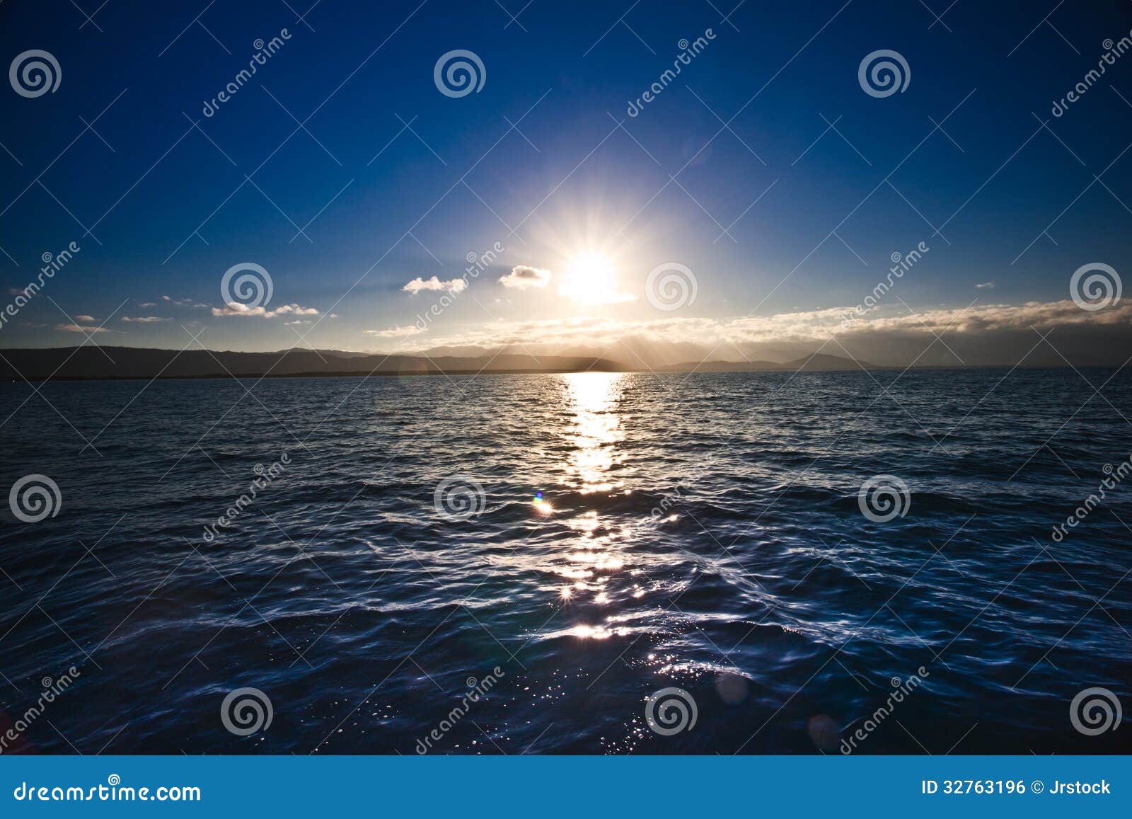 Sun setting over the ocean stock photo. Image of queensland - 32763196