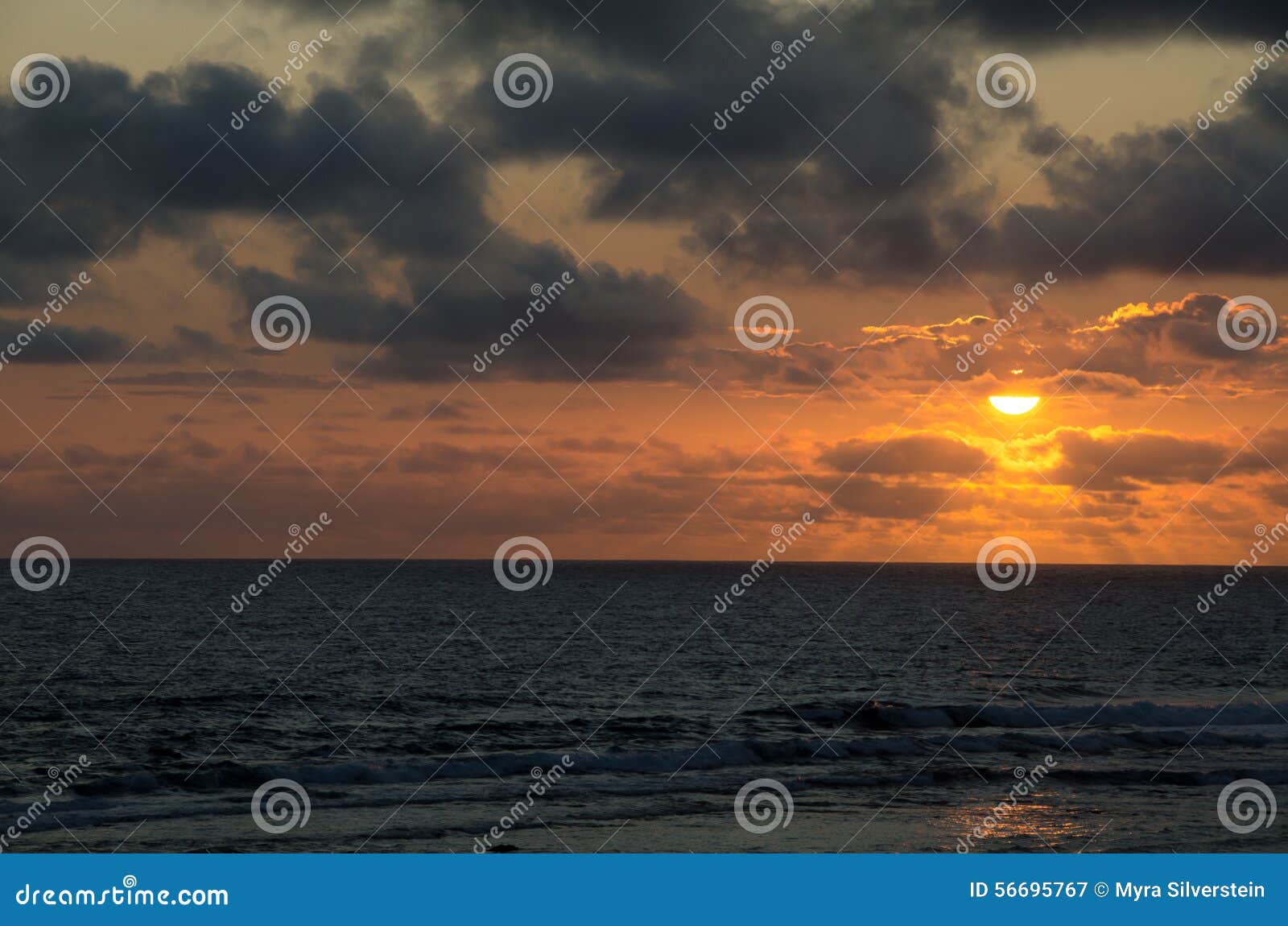 Sun setting over ocean stock image. Image of sunset, dusk - 56695767