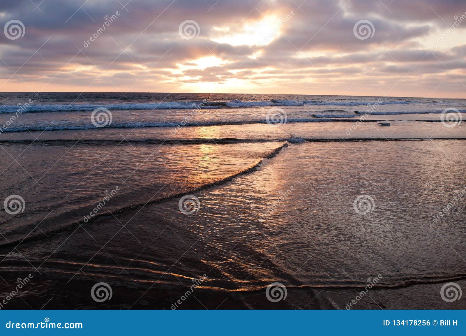 The Sun Setting Over the Pacific Ocean Seen from a Beach Stock Photo ...