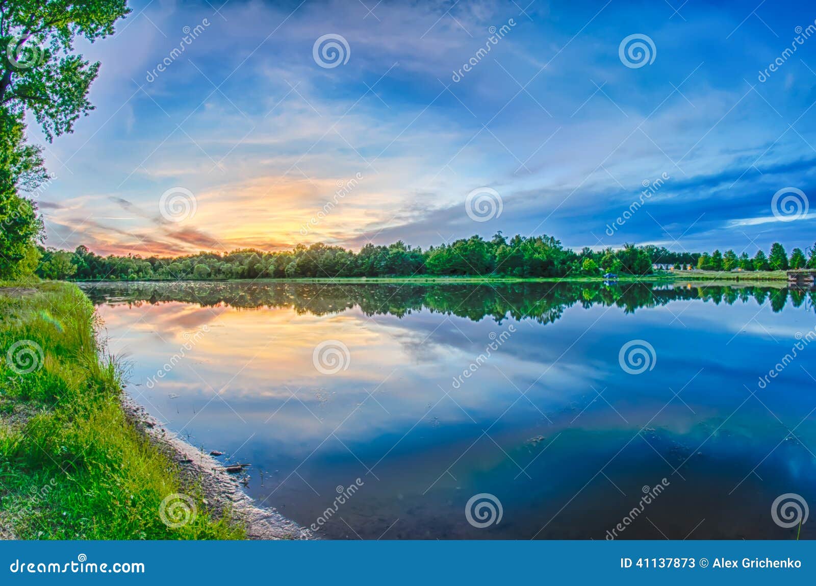 Sun Setting Over a Reflective Lake Stock Image - Image of outdoors ...