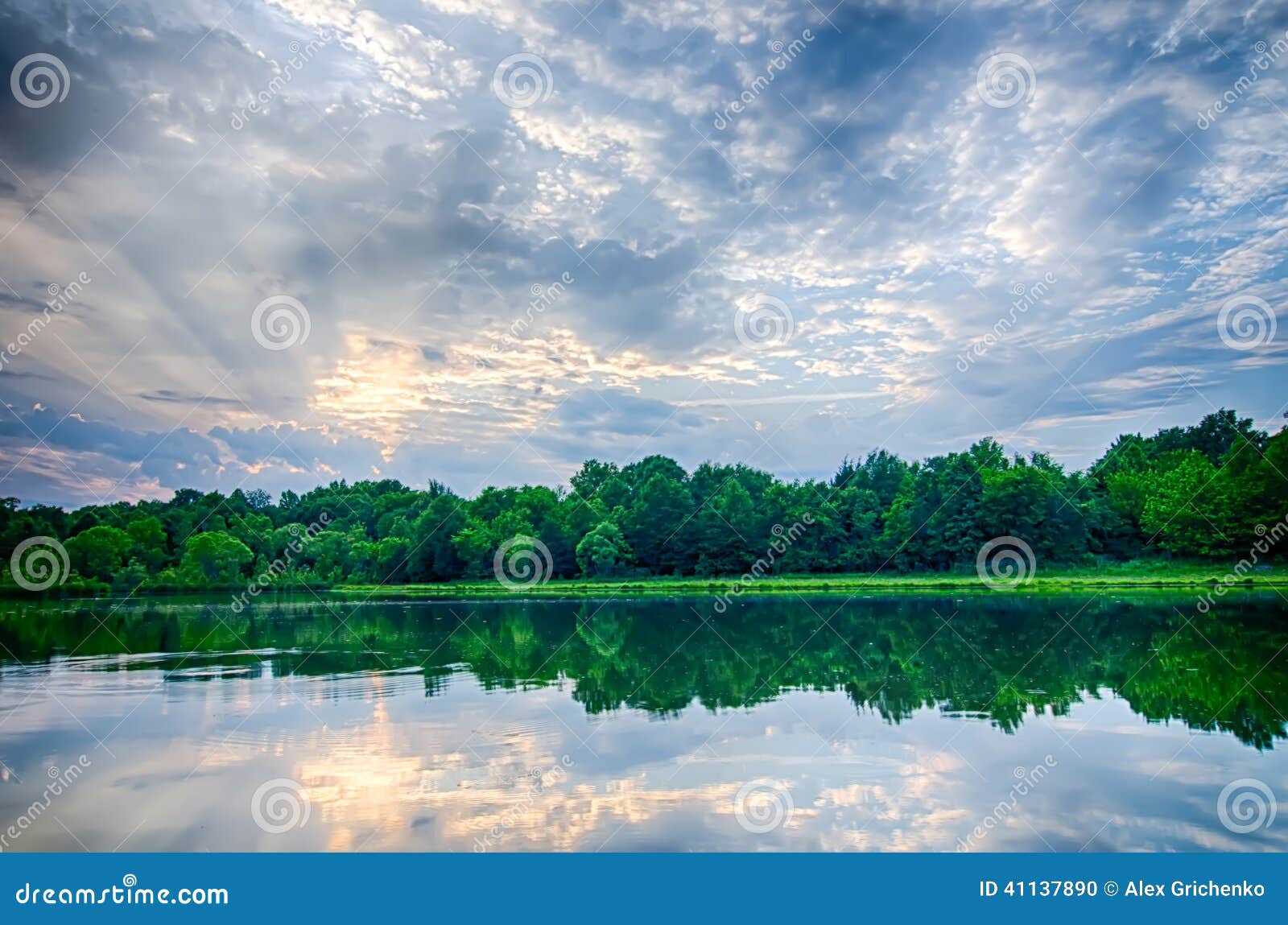 Sun Setting Over a Reflective Lake Stock Photo - Image of view, dawn ...