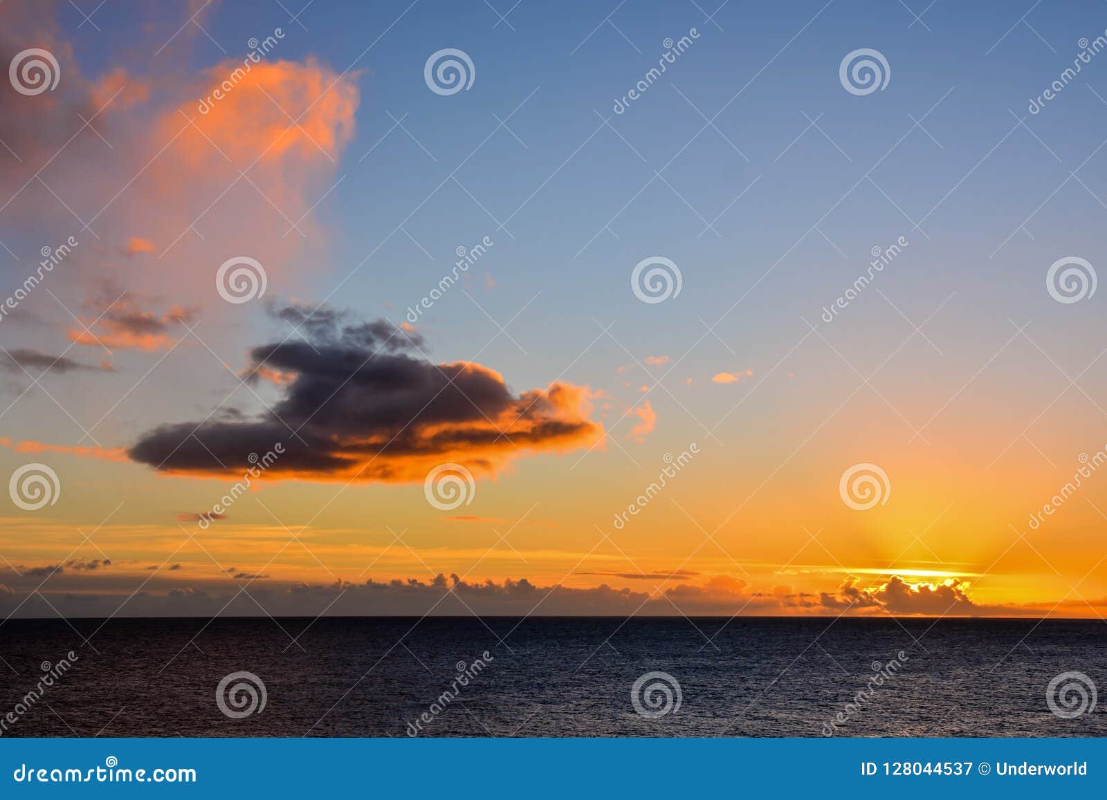 The Sun Setting in the Sea stock image. Image of sunset - 128044537