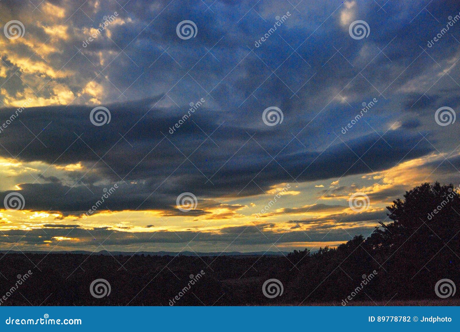 Sun Setting in a Storm Cloud Covered Late Summer Sky Stock Photo ...